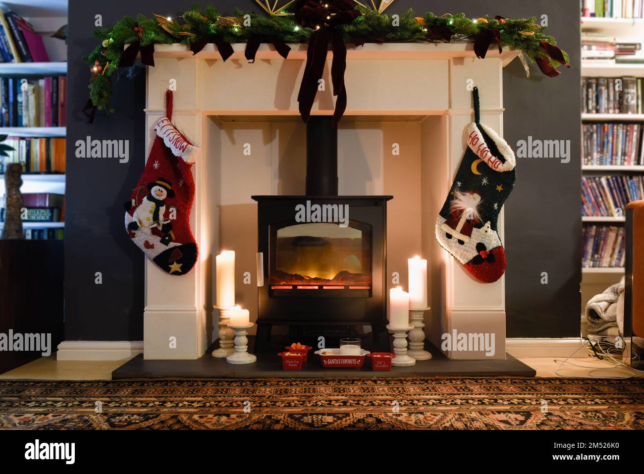 Christmas interior of living room fire place with stockings hanging by ...