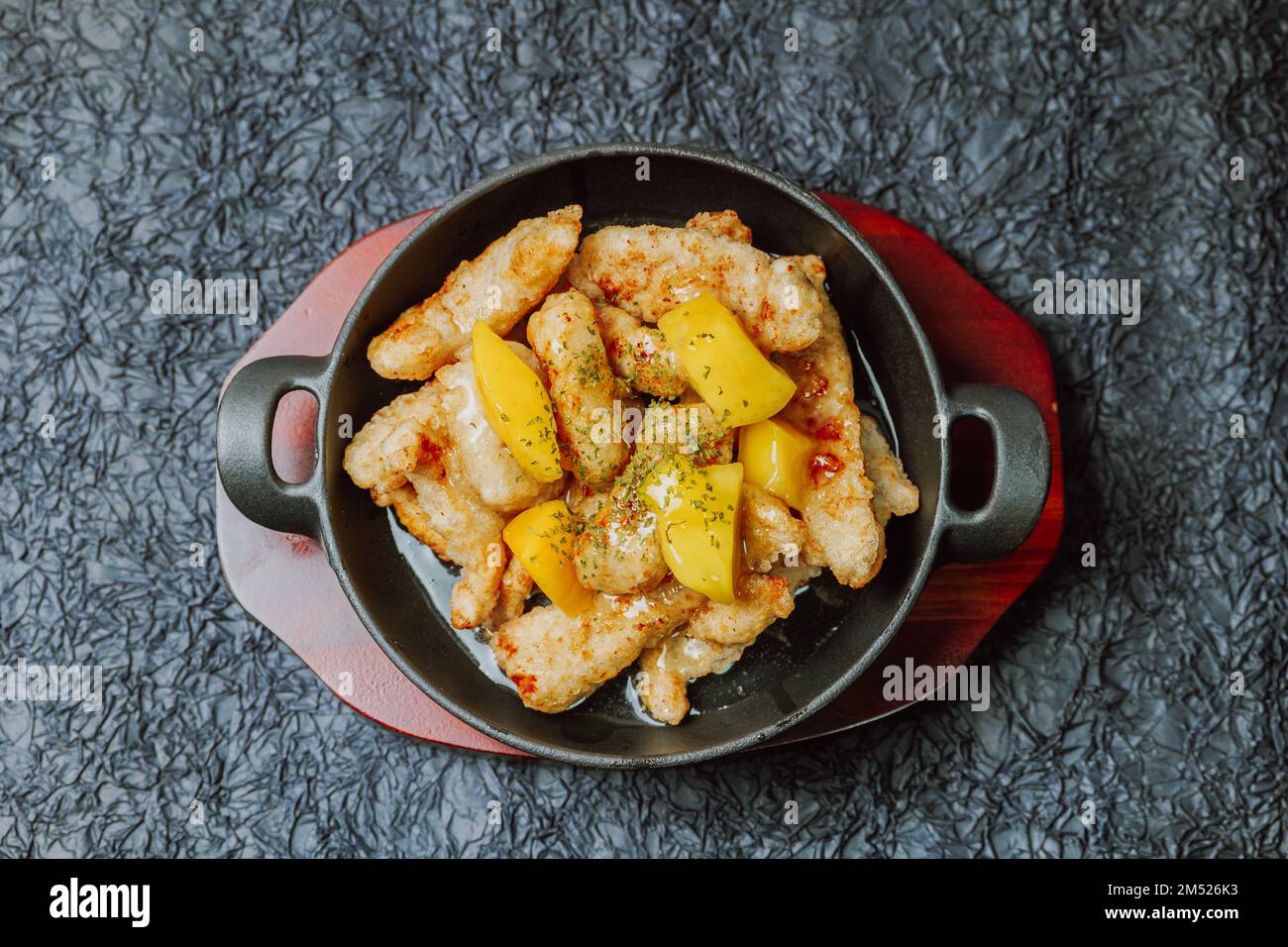 Chinese food sweet and sour pork dish in black bowl Stock Photo - Alamy