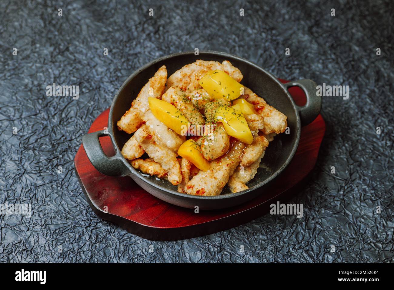 Chinese food sweet and sour pork dish in black bowl Stock Photo - Alamy