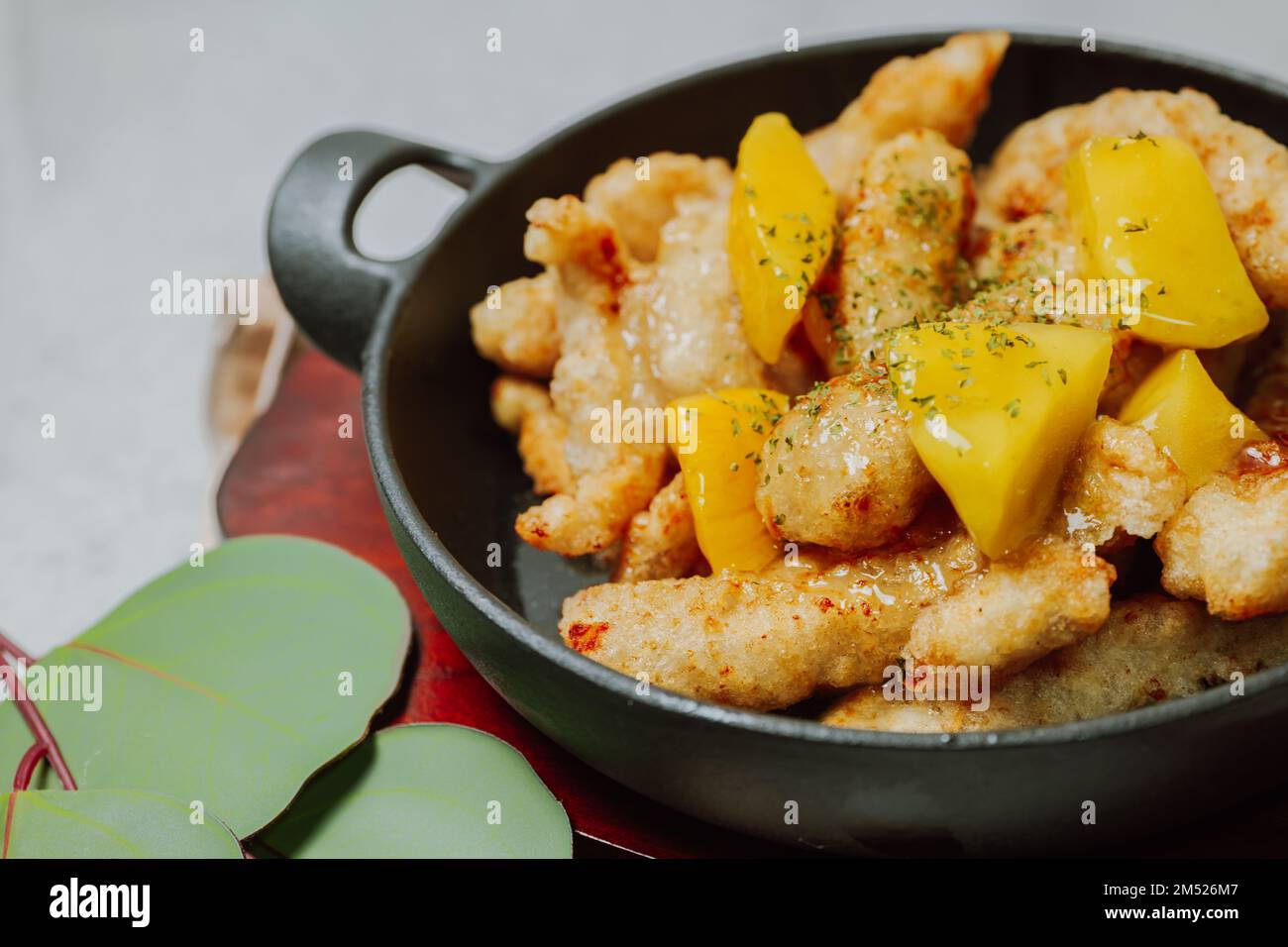 Chinese food sweet and sour pork dish in black bowl Stock Photo - Alamy