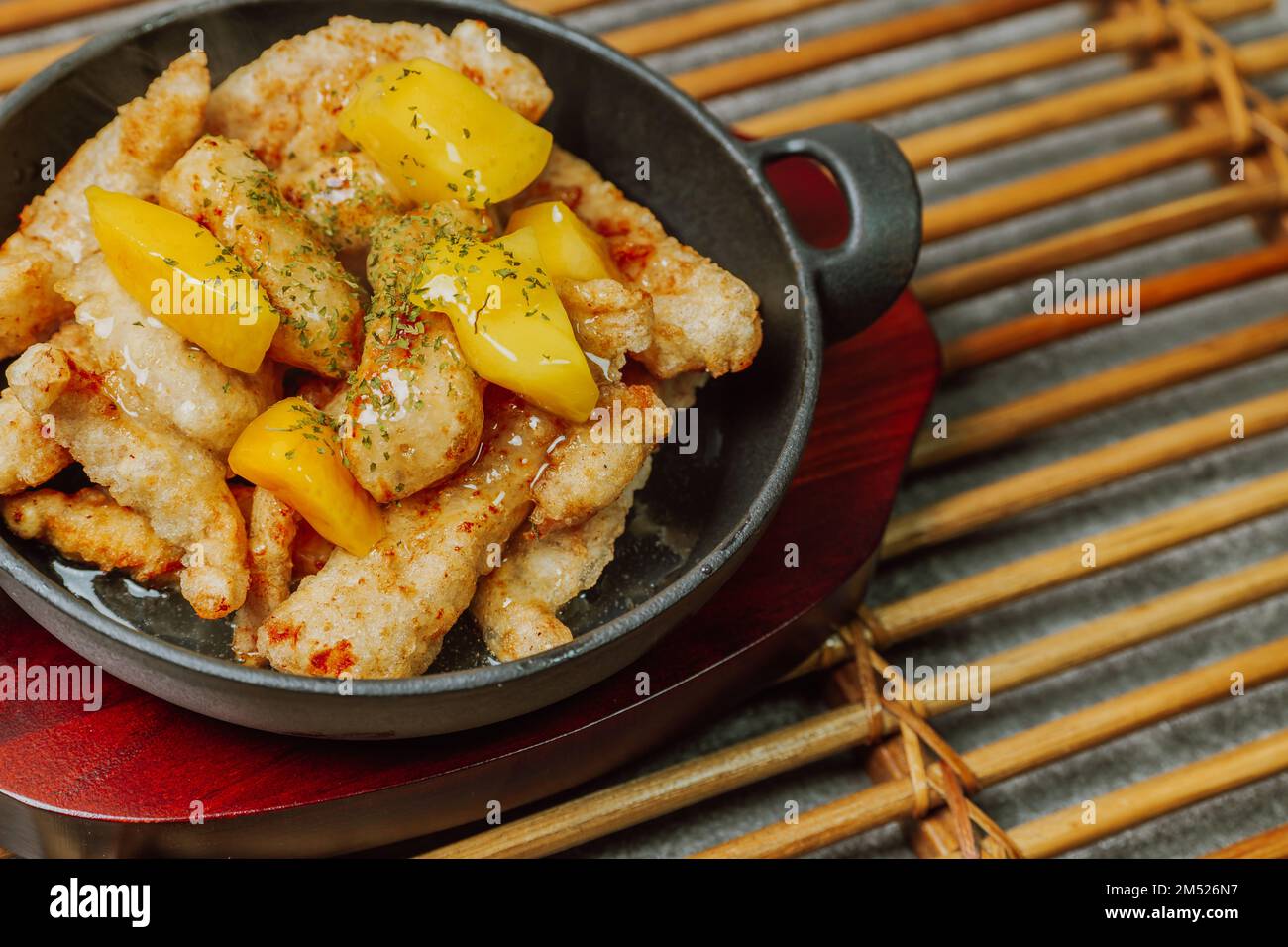 Chinese food sweet and sour pork dish in black bowl Stock Photo - Alamy