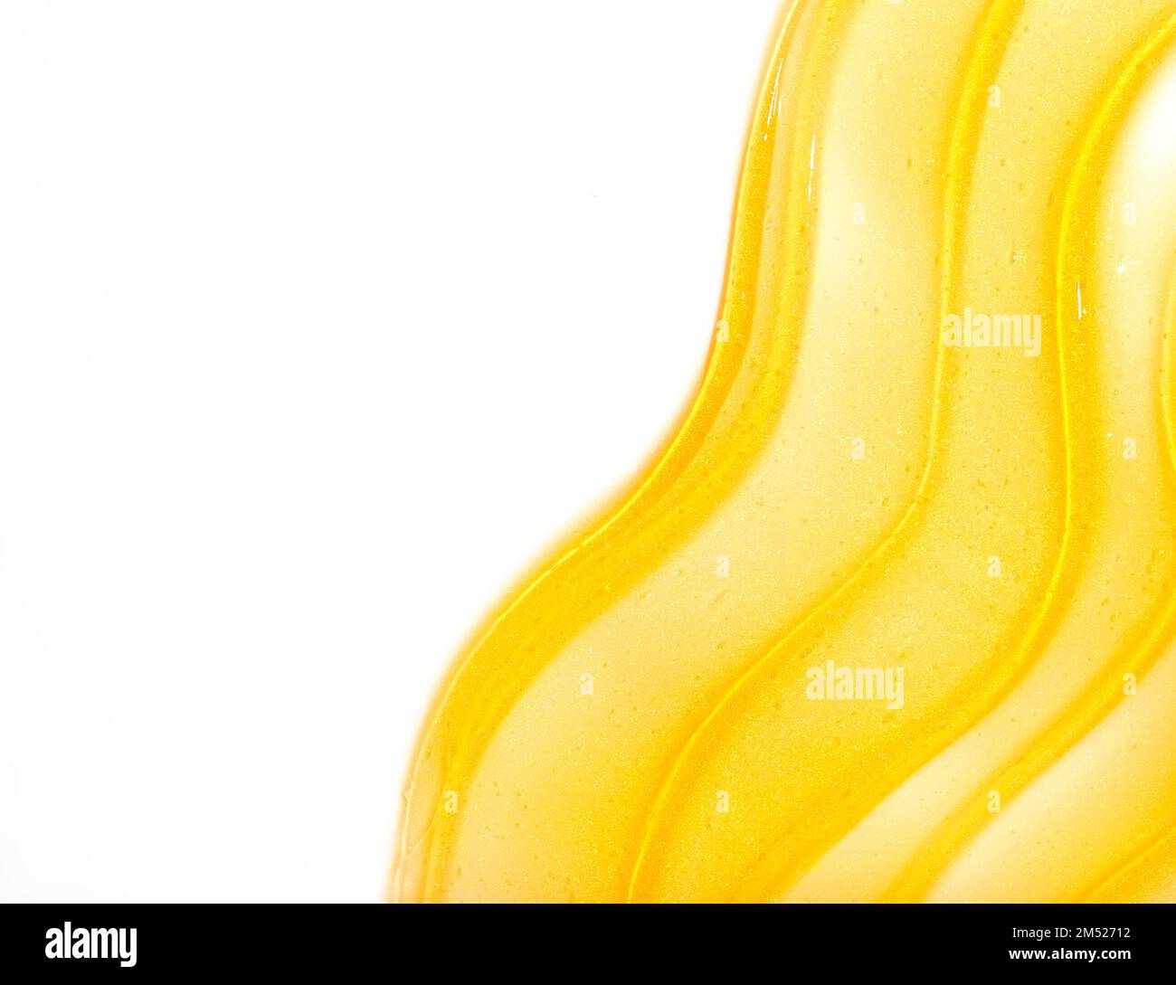 The gold skincare slushed on a white background Stock Photo - Alamy