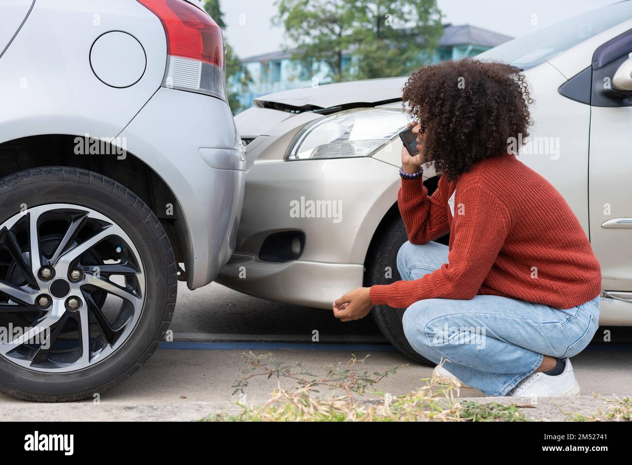 Asian women driver check for damage after a car accident before taking ...