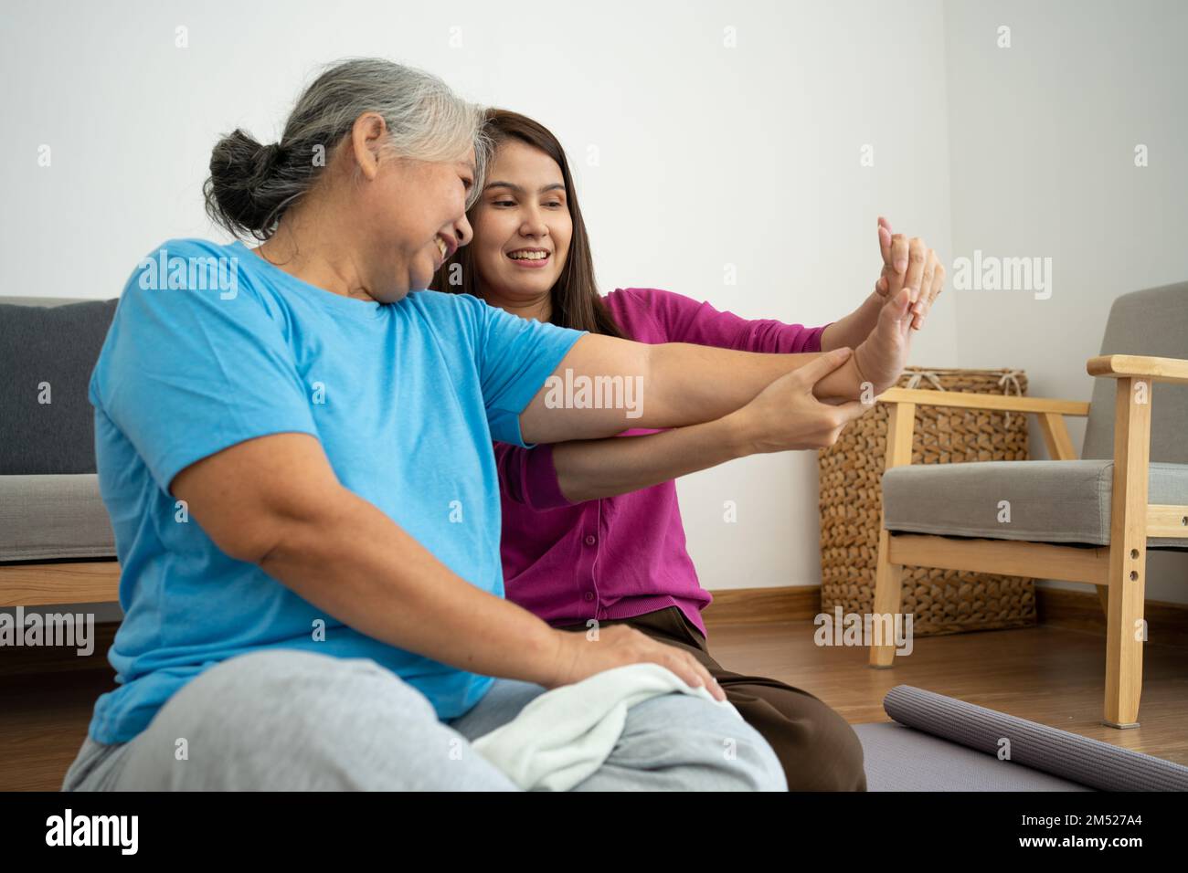 Asian careful caregiver or nurse taking care of the patient in a home ...