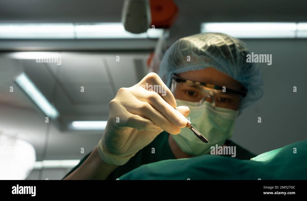 Asian Professional surgeons team performing surgery in the operating ...