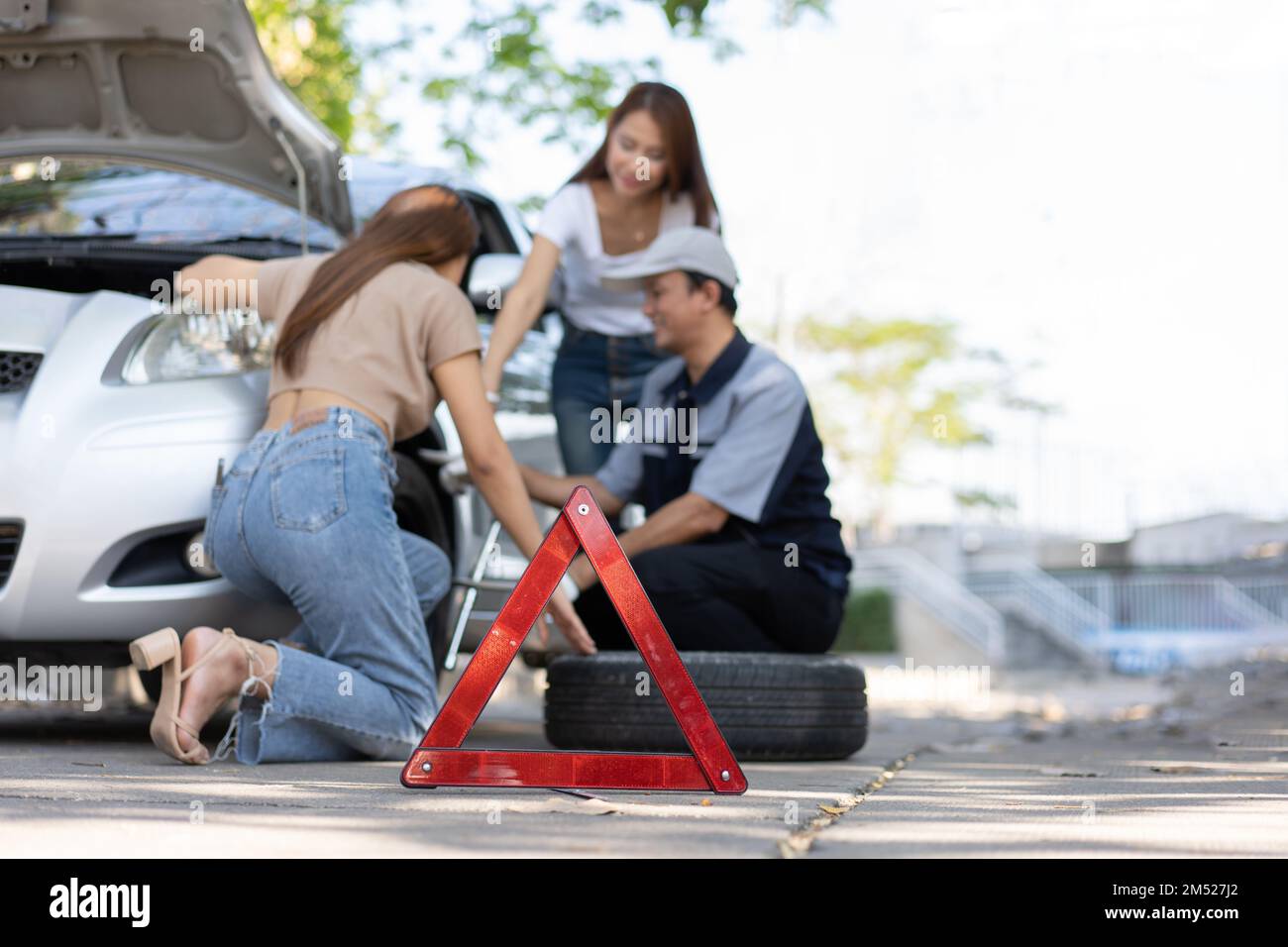 Expertise mechanic man in uniform using force trying to unscrew the ...