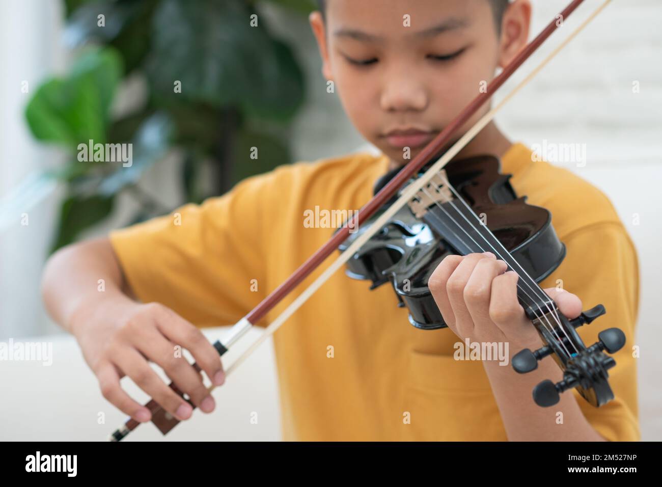 Boy practicing violin hi-res stock photography and images - Alamy