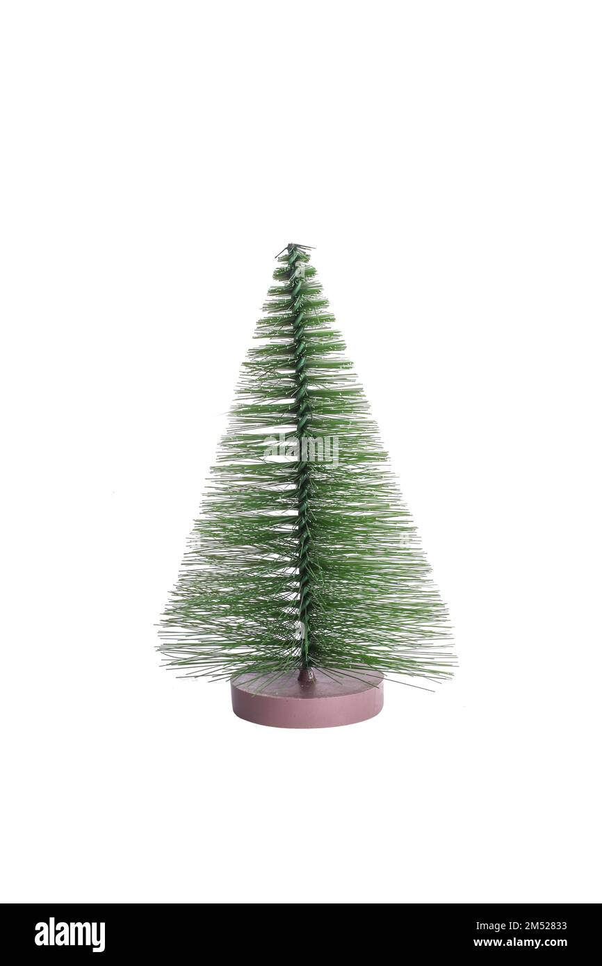 A cute small miniature Christmas tree isolated on white background ...