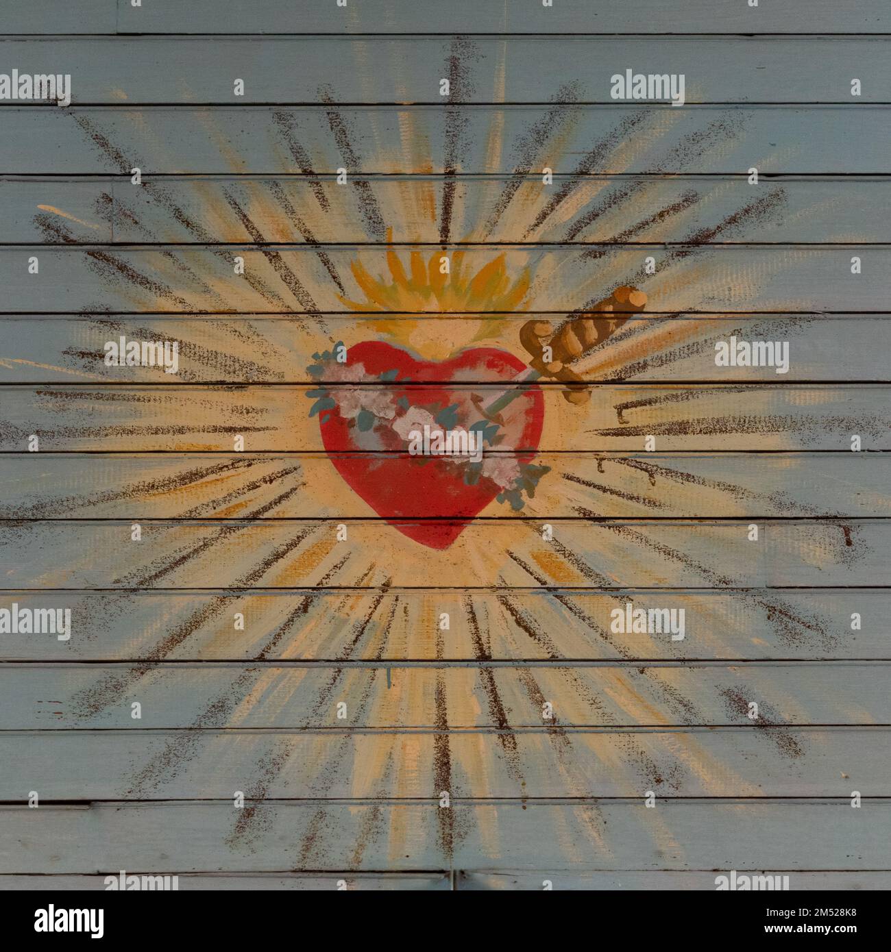 Close Up of a sacred heart with flowers, flames, and a sharp sword on ...