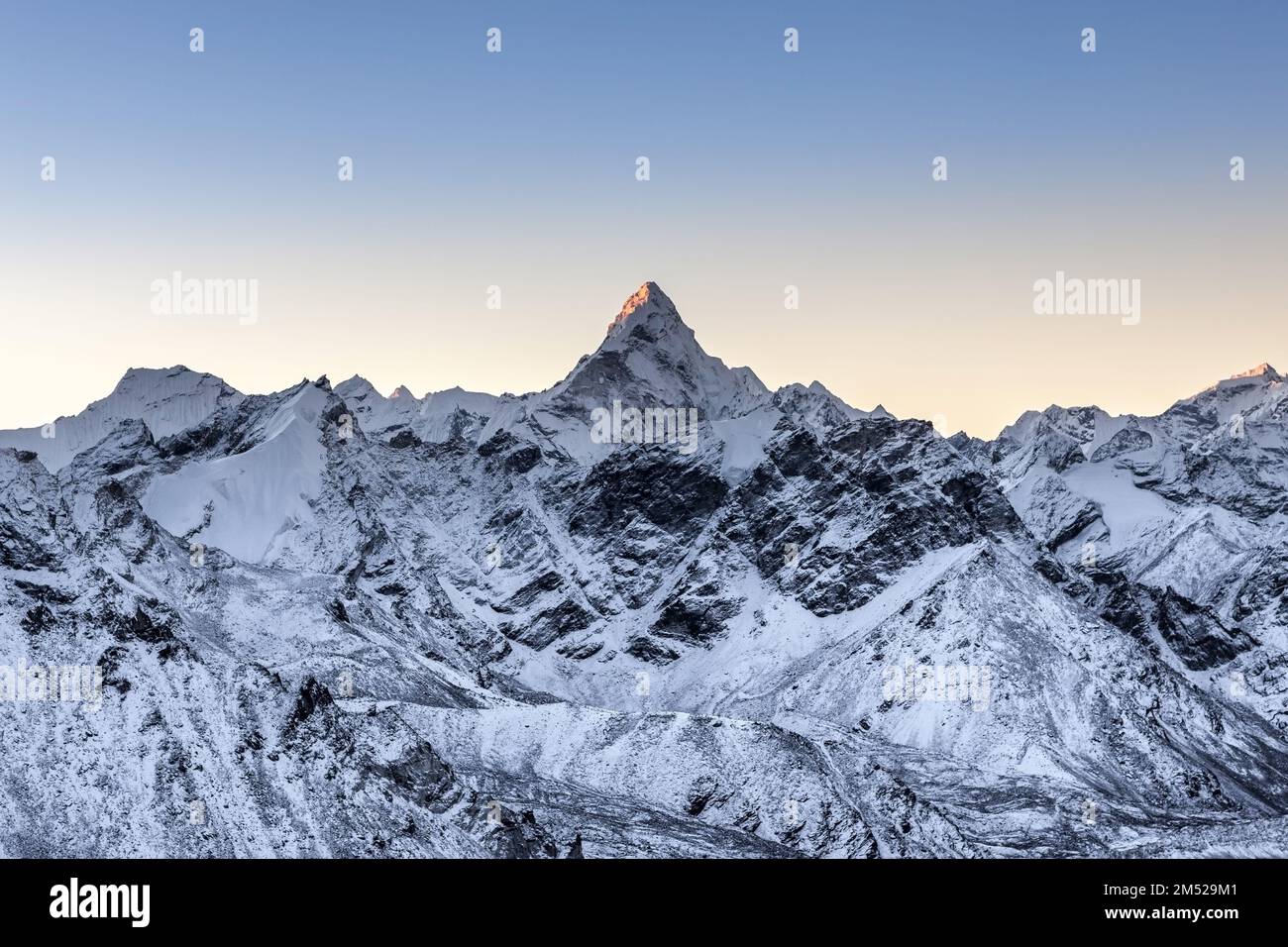 Beautiful Ama Dablam peak lit by the very first ray of morning sun ...
