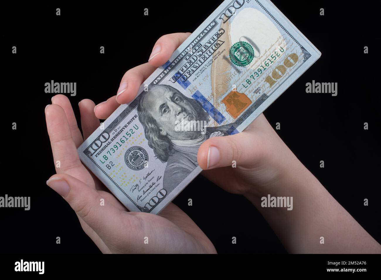 Hand holding American dollar banknotes isolated on white background ...