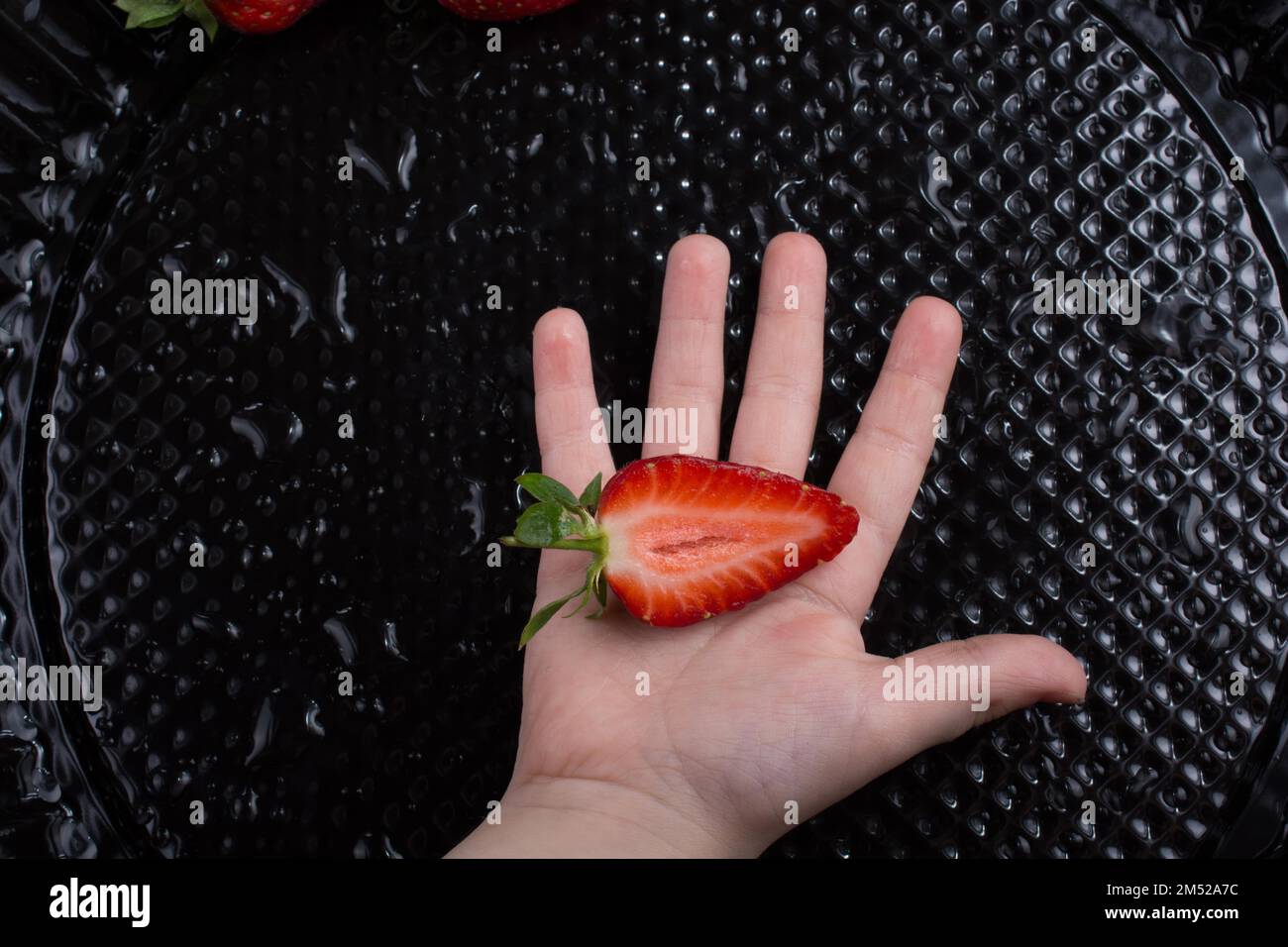 Juicy, sweet and ripe strawberry fruit in hand Stock Photo - Alamy