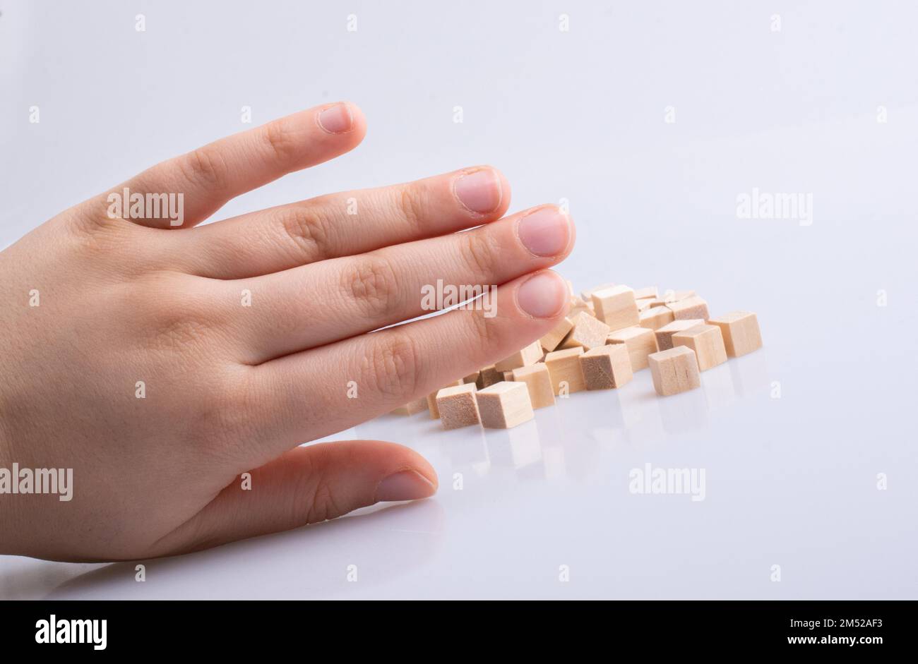 Hand playing with wooden cubes as educational and business concept ...