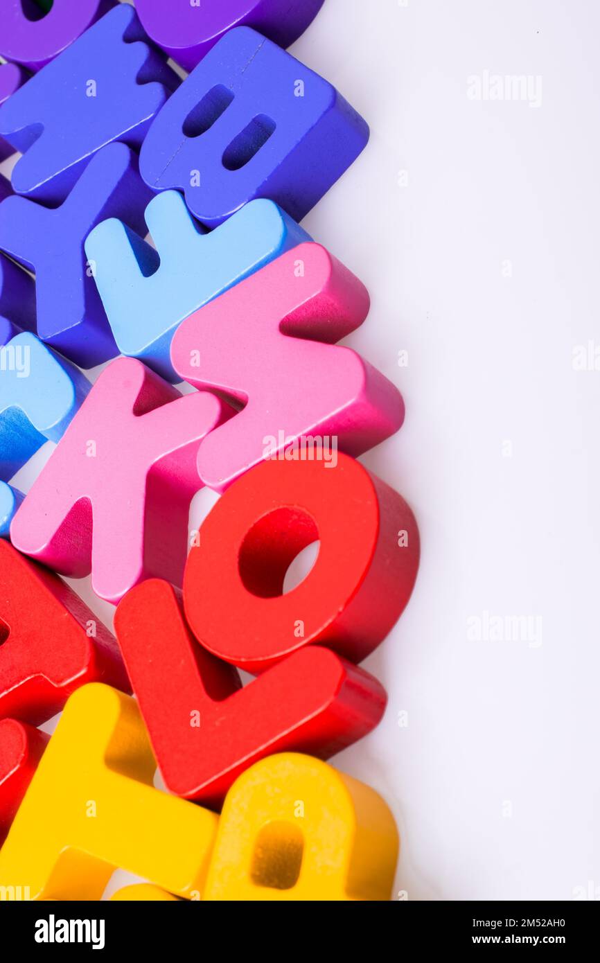 Colorful alphabet letter blocks scattered randomly on white background ...