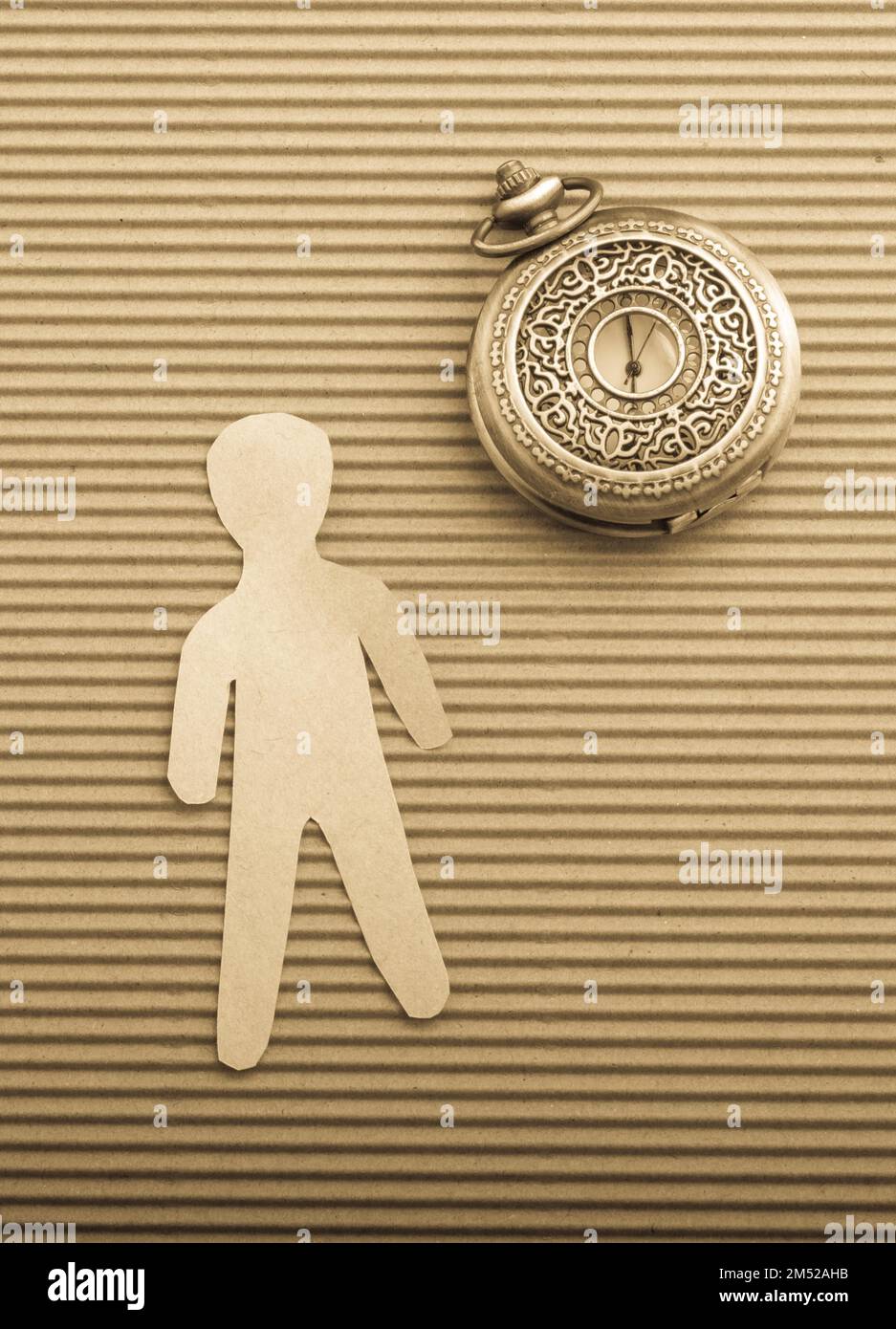 Paper man shape and a retro pocket watch Stock Photo - Alamy