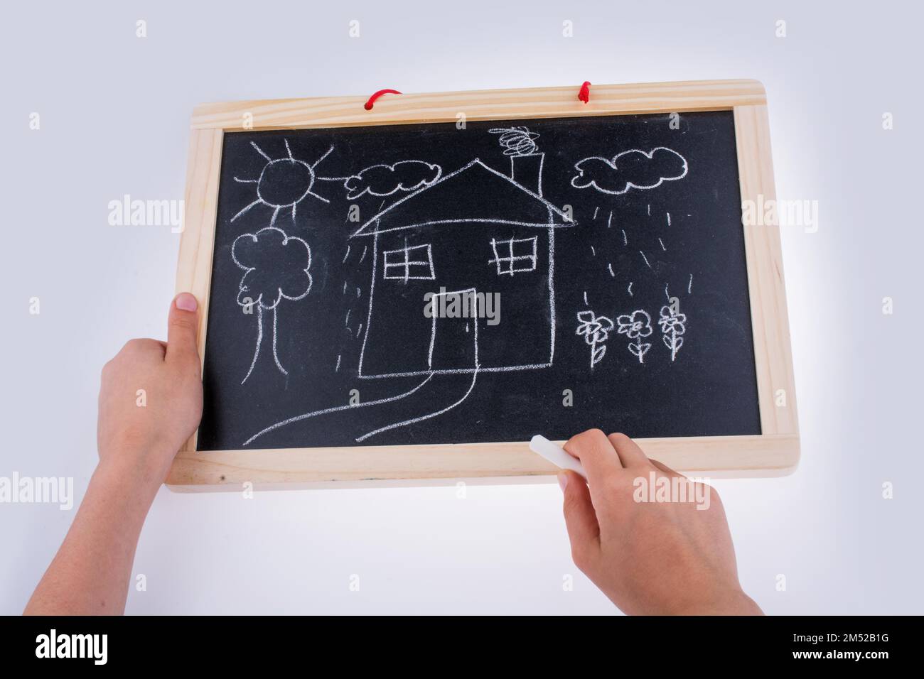 Hand drawing a house on the blackboard with a chalk Stock Photo - Alamy