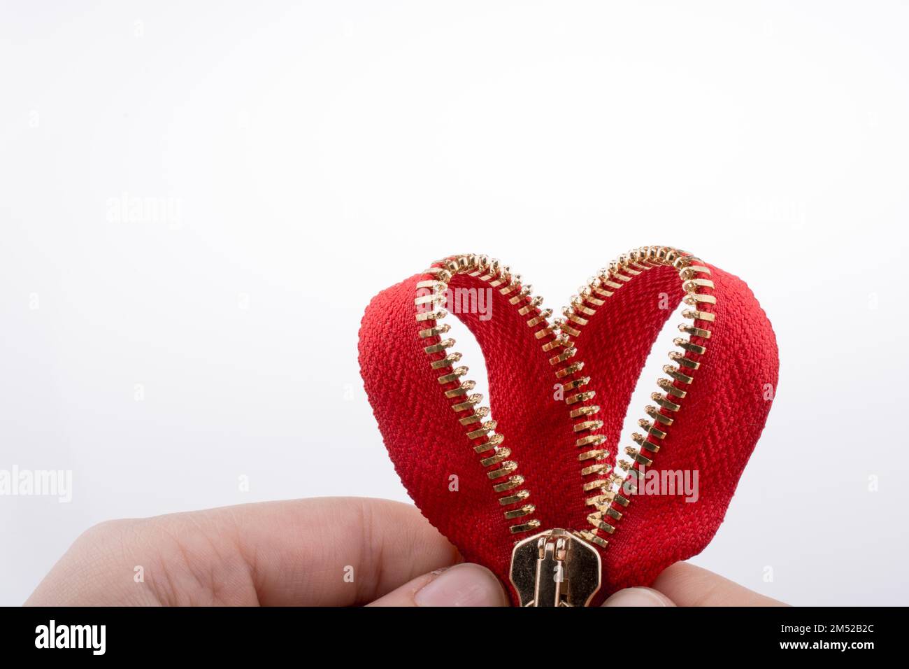 Heart shaped zipper on a white background Stock Photo - Alamy