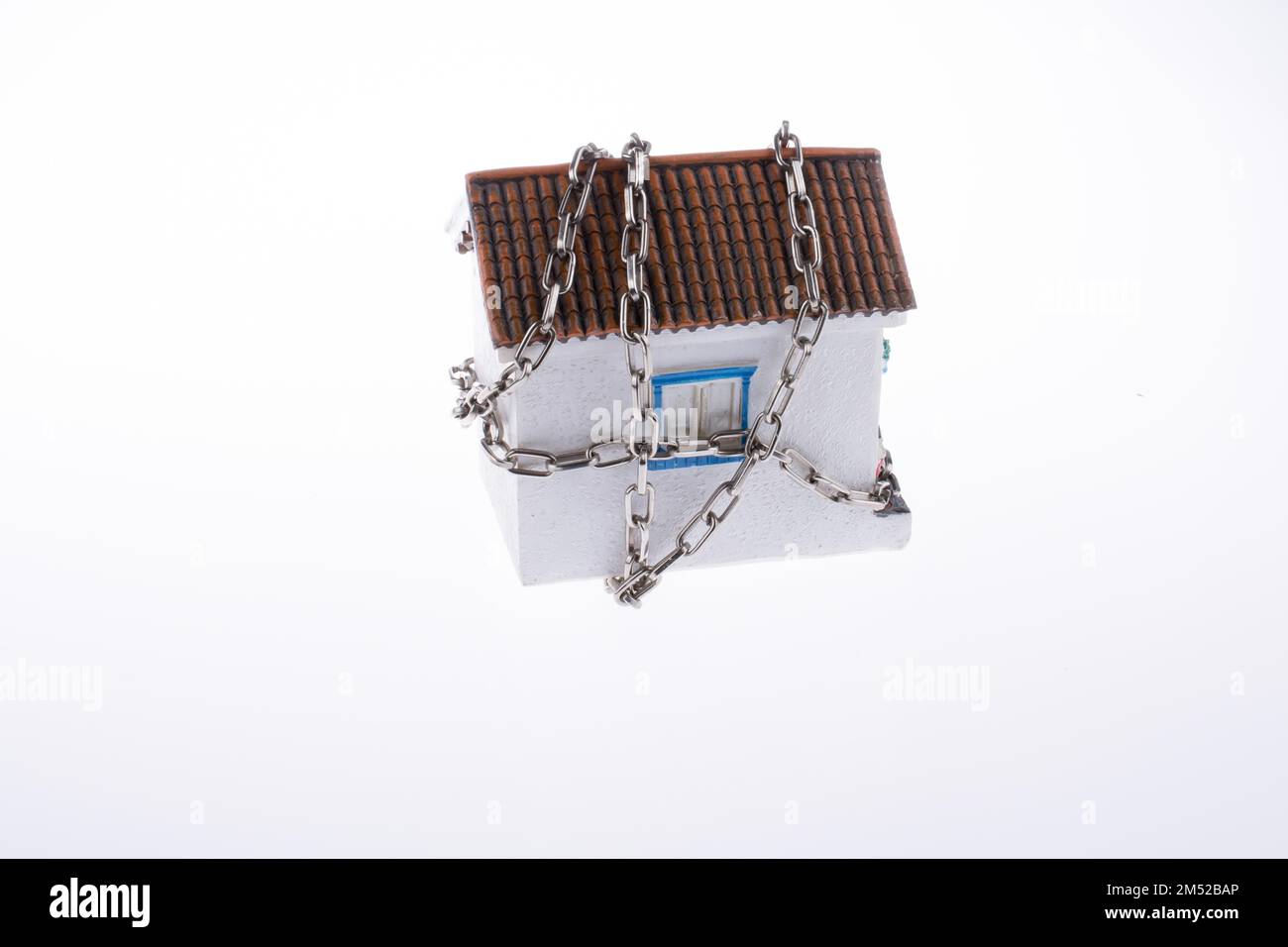 House in chains on a white background Stock Photo - Alamy