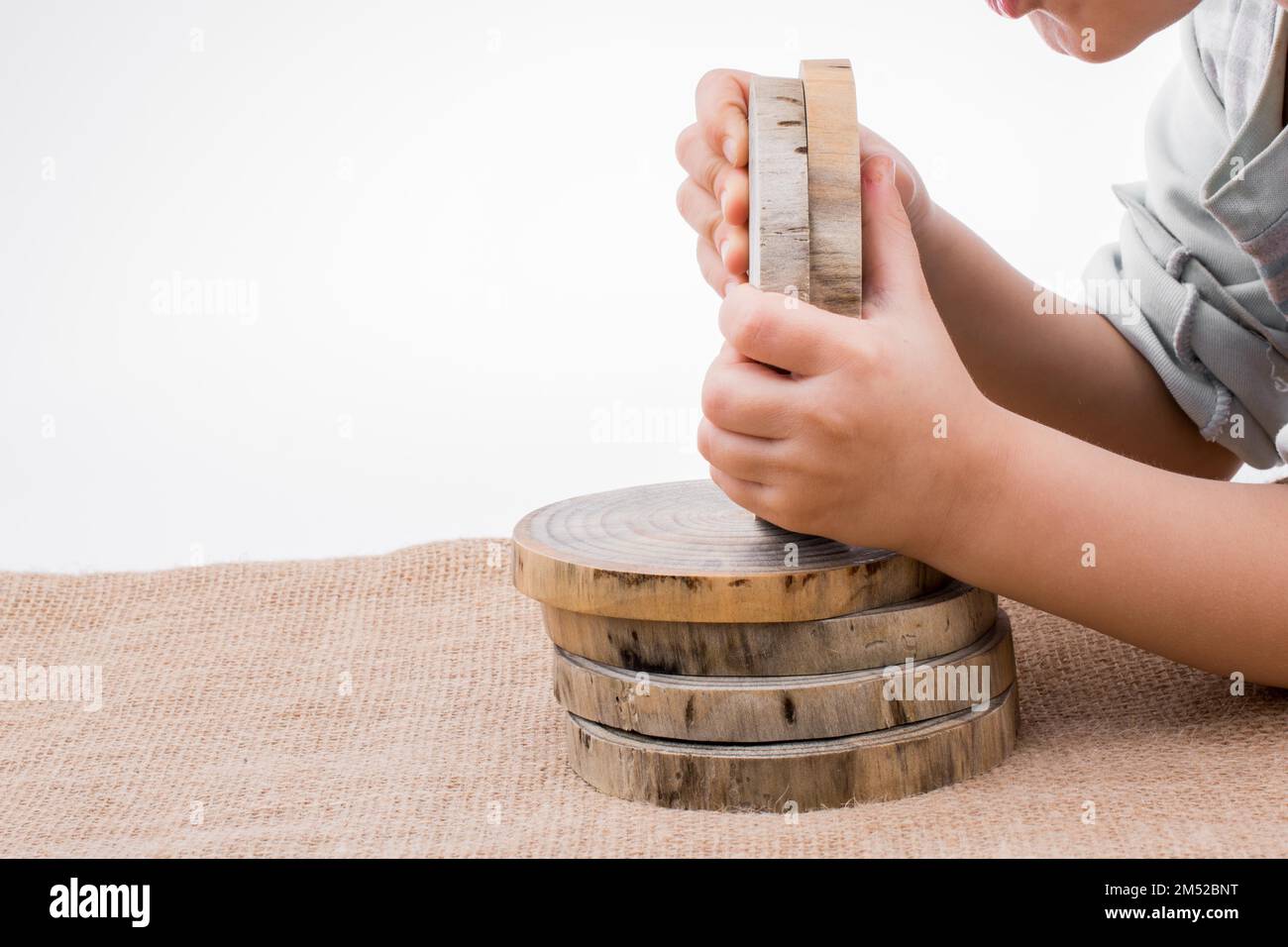 Wood Log cut in round thin pieces in hand Stock Photo - Alamy