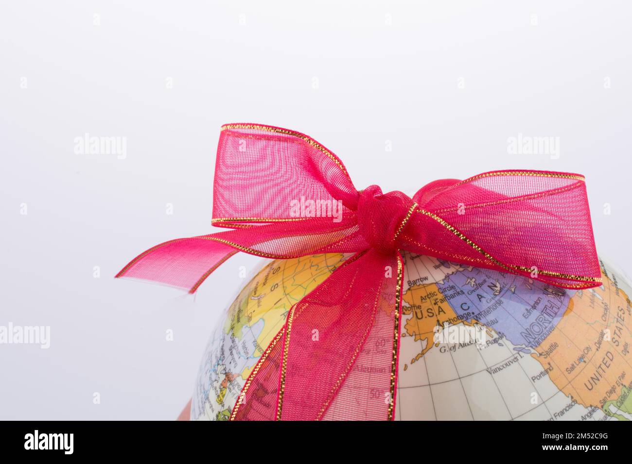 Globe tied red ribbon hi-res stock photography and images - Alamy