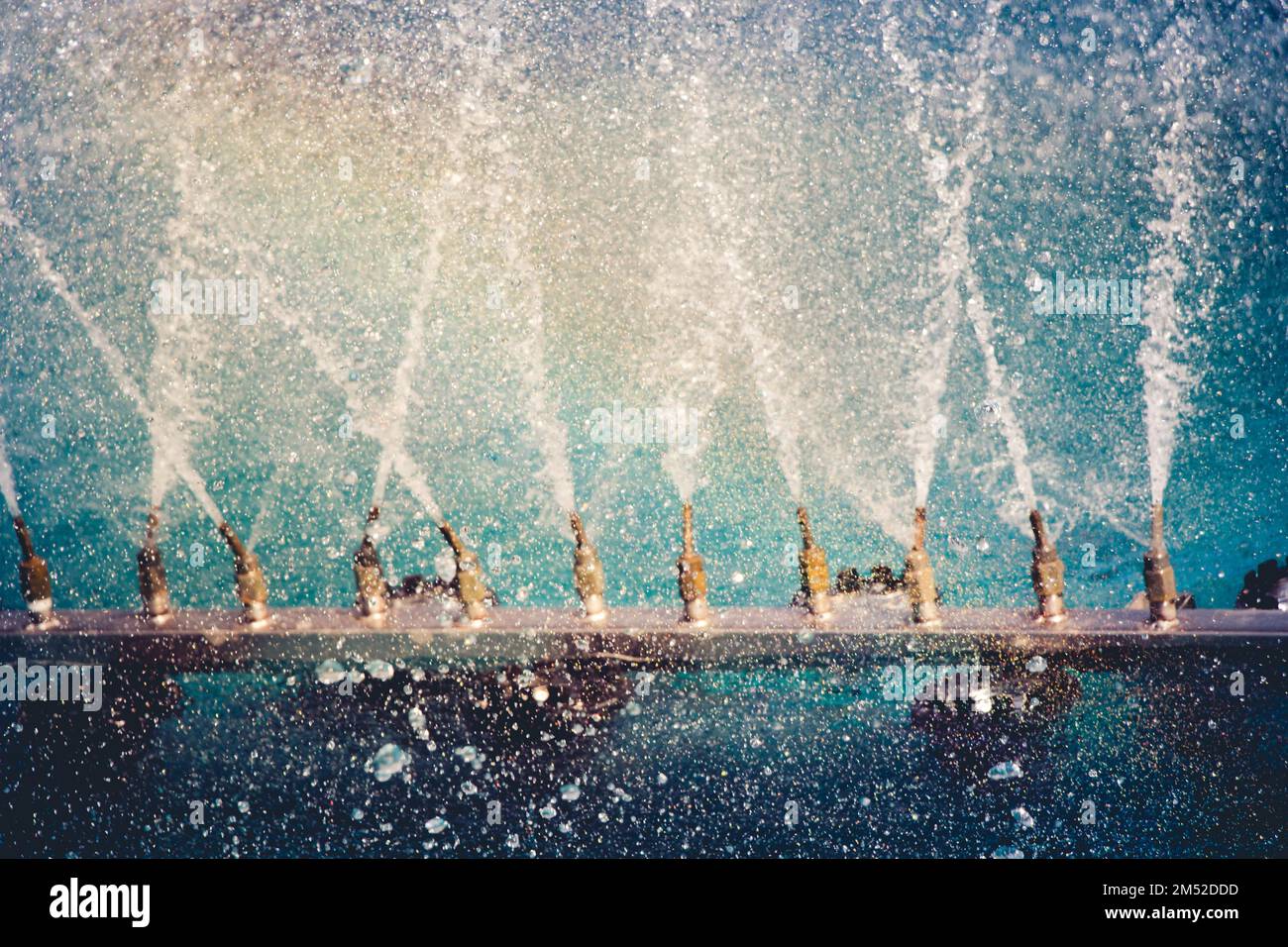A water fountain sprinkling water in the view Stock Photo - Alamy