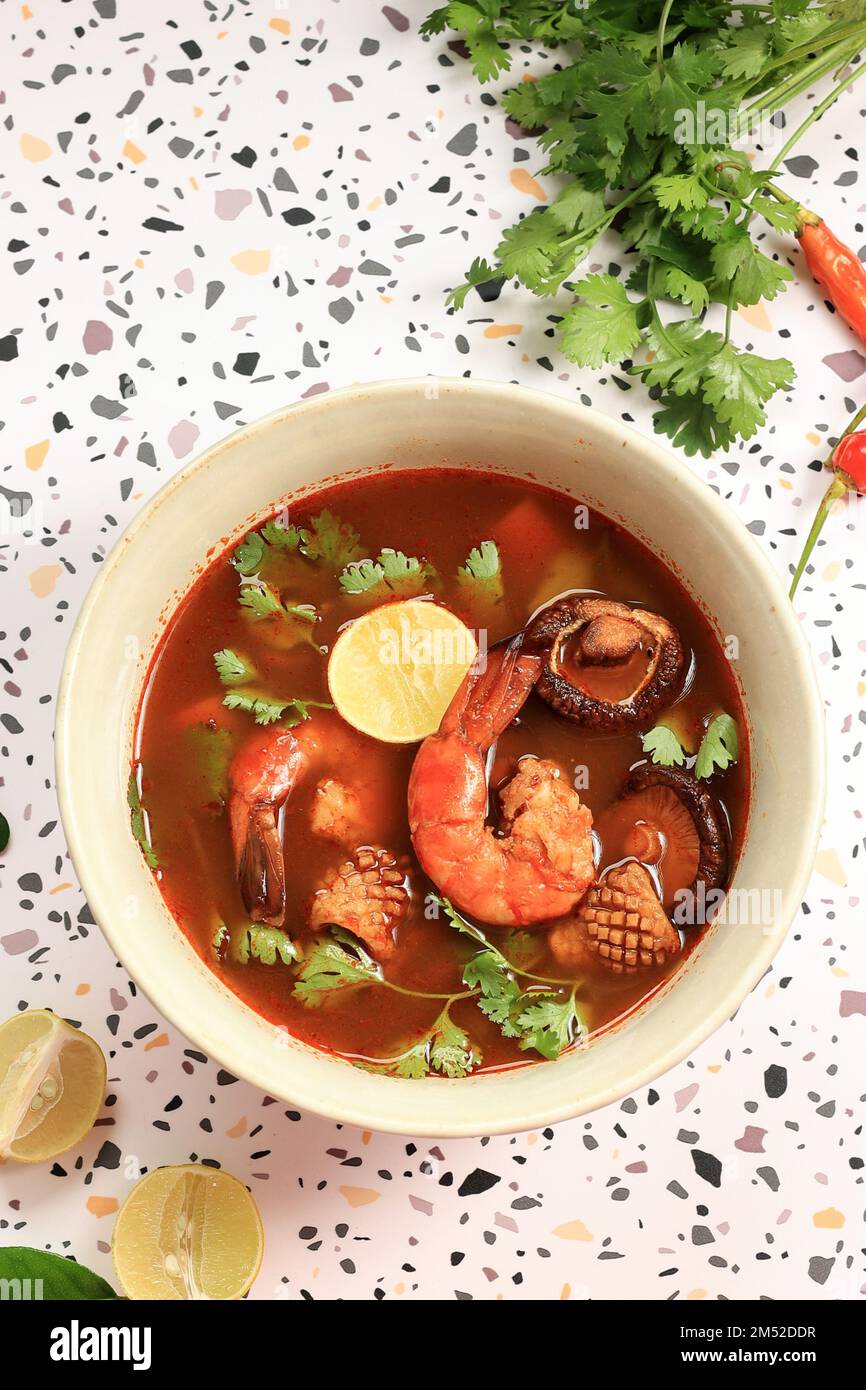 Top View Tom Yum Gung with Prawn, Squid, and Mushroom. Served with ...