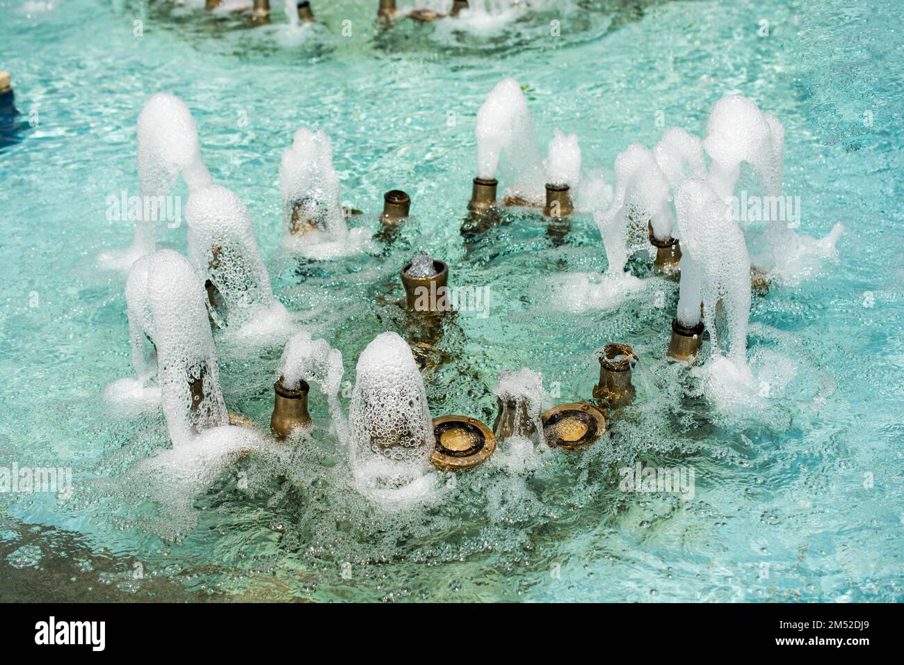 The fountains gushing sparkling water in a pool in a park Stock Photo ...