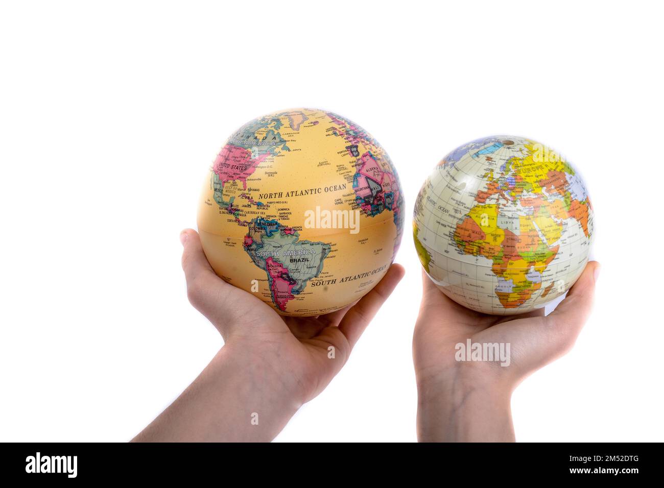 Two hands holding holding two globes in hand on white background Stock ...