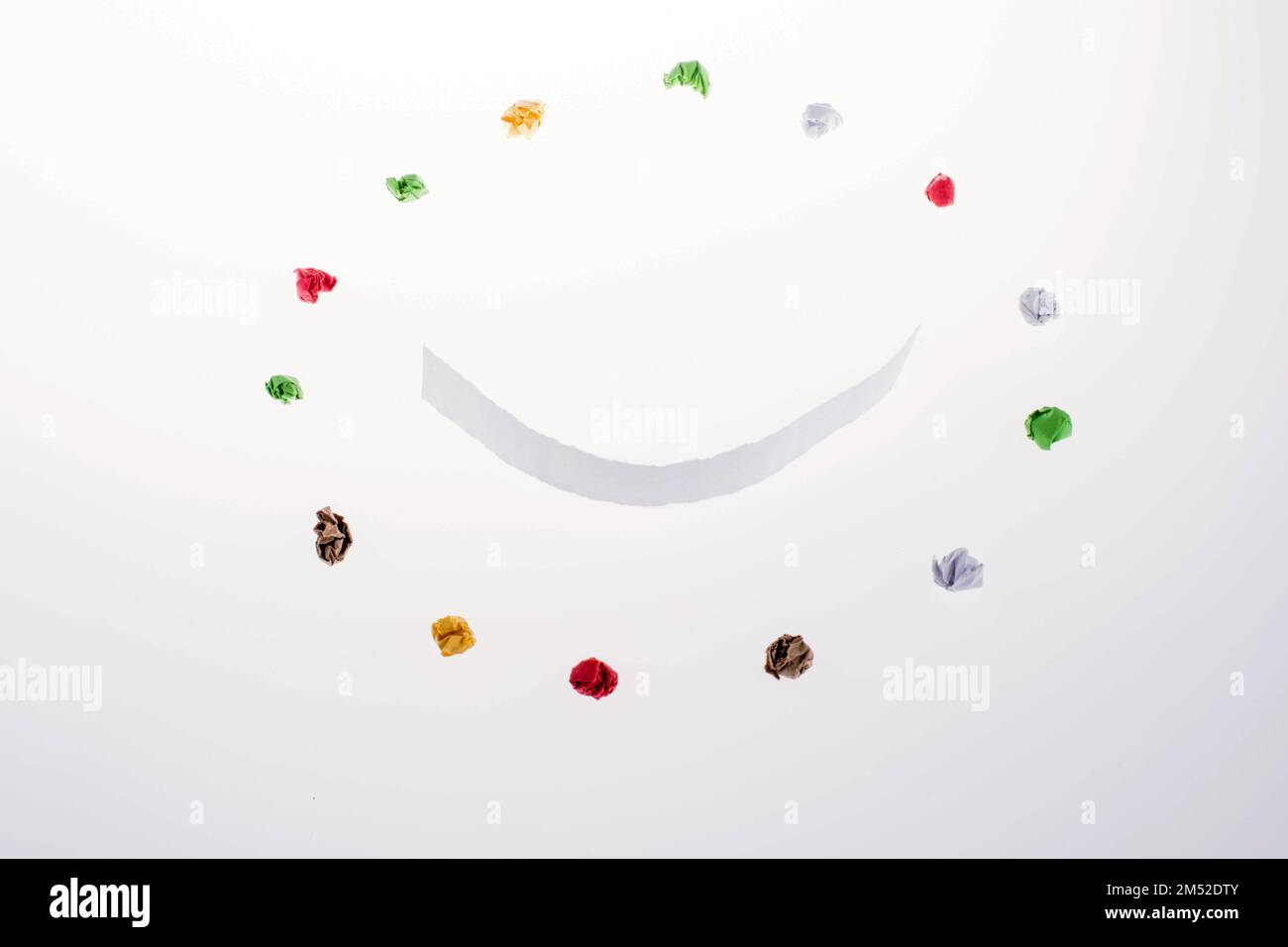 Colorful crumpled papers form a round shape around a smile Stock Photo ...