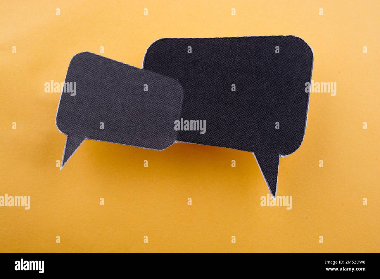 Dialogue boxes on a yellow background Stock Photo - Alamy