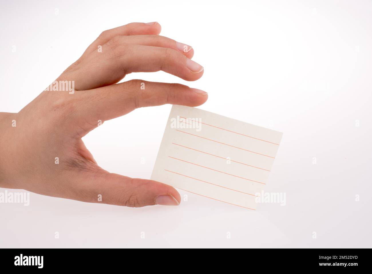 Hand holding a piece of lined paper on a white background Stock Photo ...