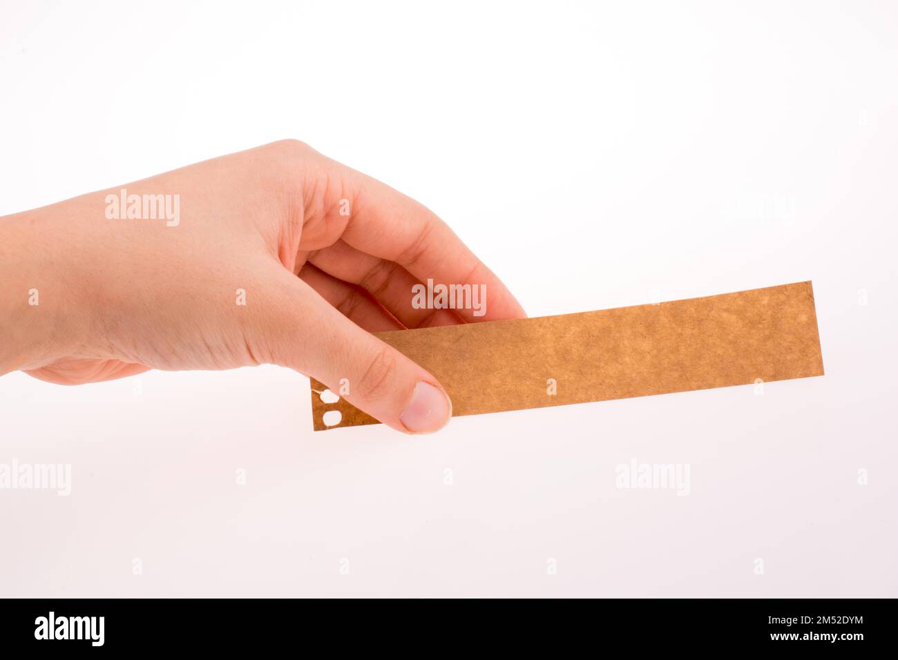 Hand holding a piece of paper on a white background Stock Photo - Alamy