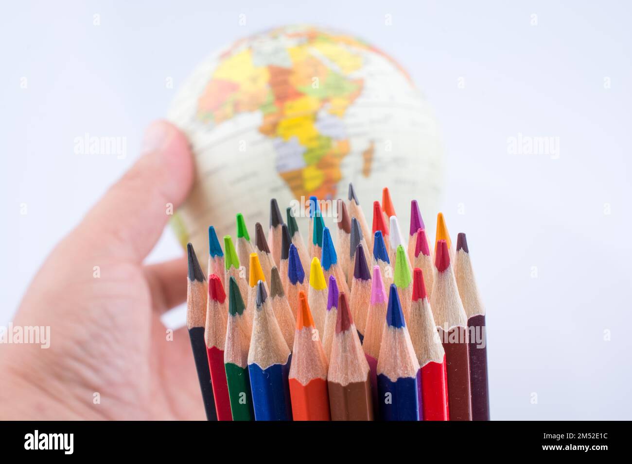 Color pencils of various color and globe on white background Stock ...