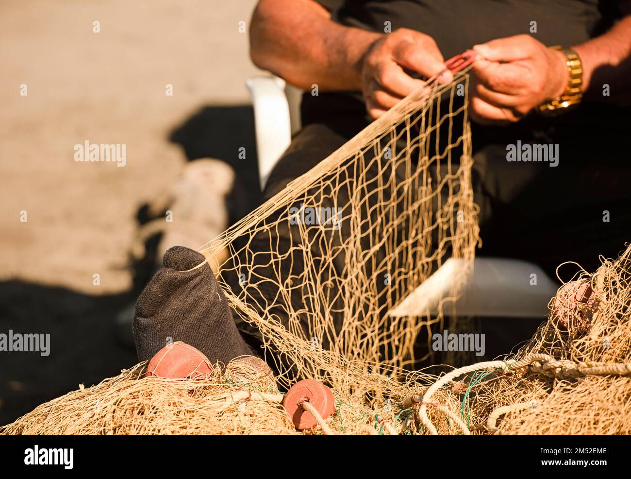 fishing net in the hands of fisherman, with needle and thread, grabs ...