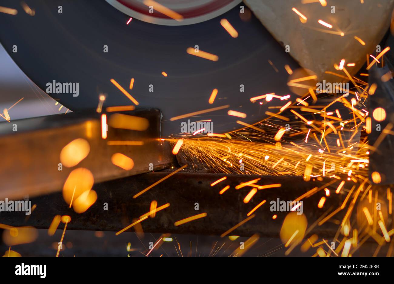 Worker cutting steel rectangular pipe in construction site Stock Photo ...