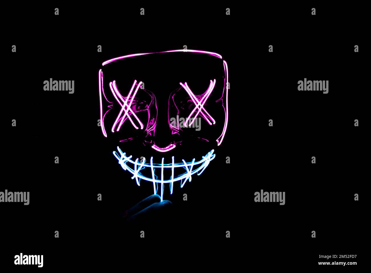 A Purple and blue Halloween led mask with black background Stock Photo ...