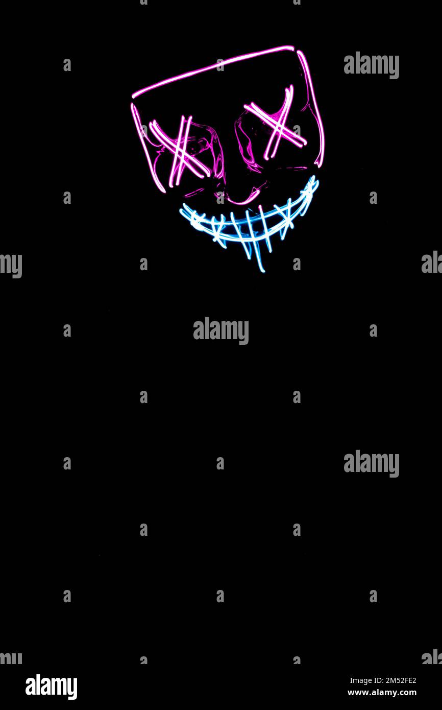 A Purple and blue Halloween led mask with black background Stock Photo ...