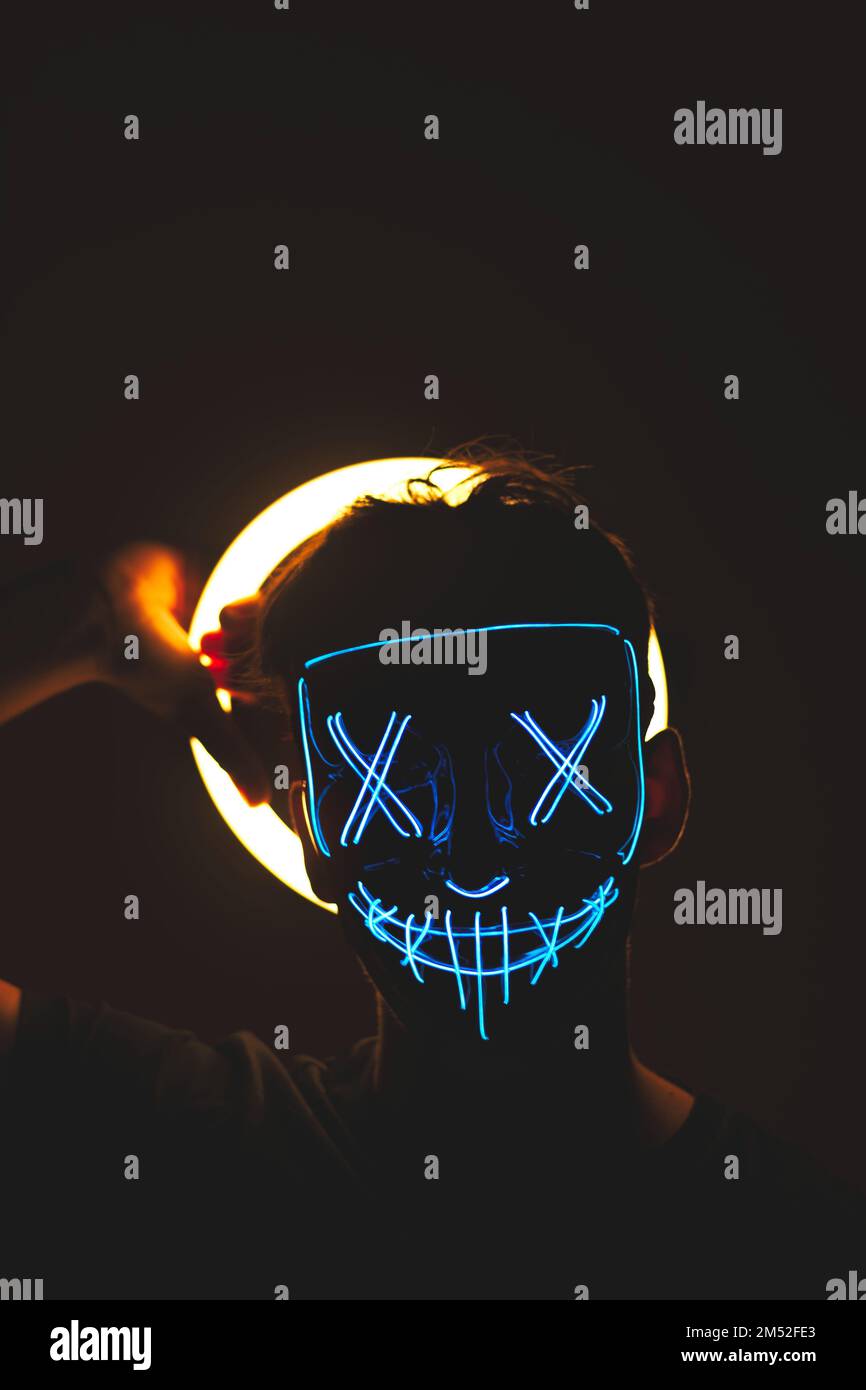 A Purple and blue Halloween led mask with black background Stock Photo ...