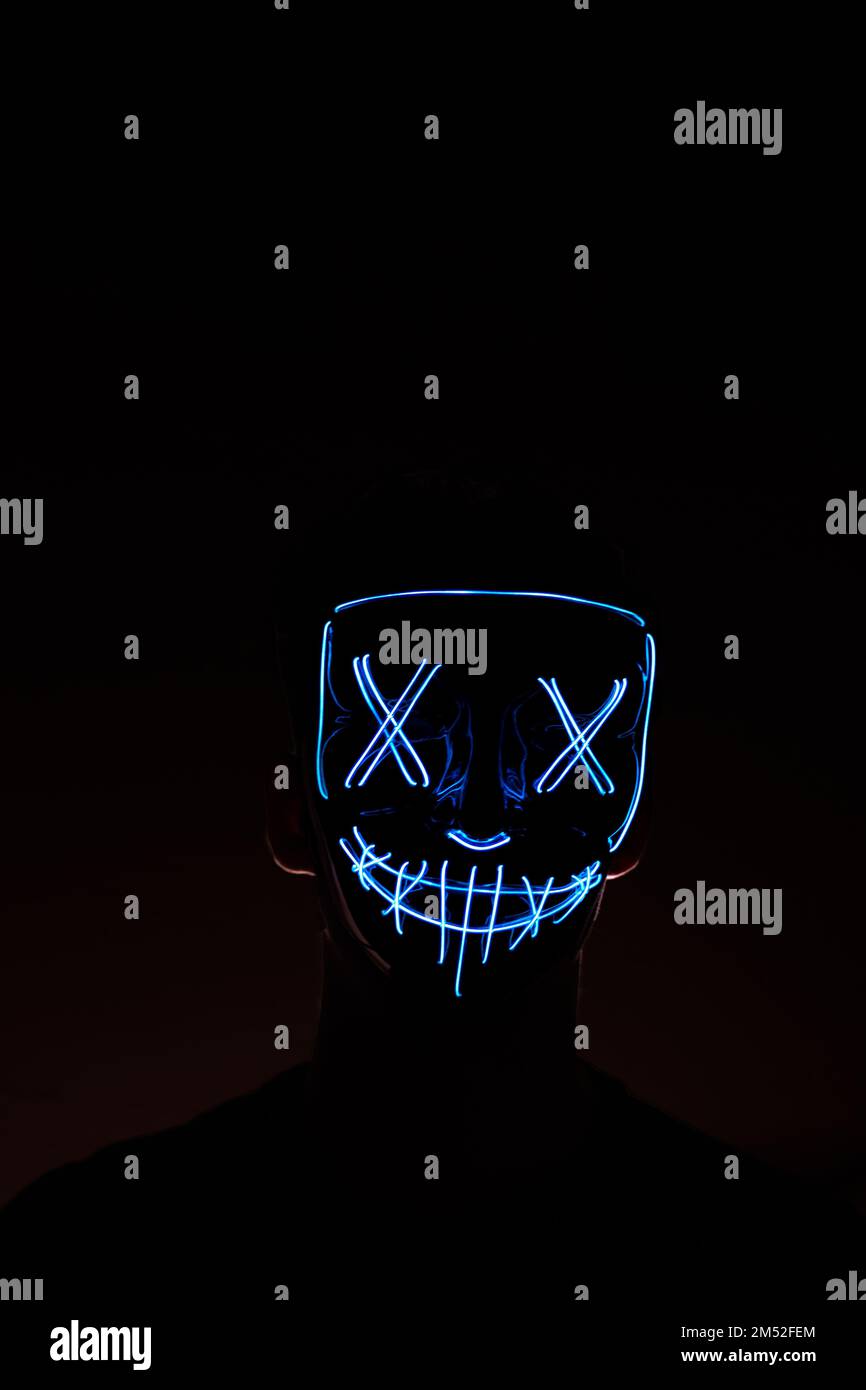 A Purple and blue Halloween led mask with black background Stock Photo ...