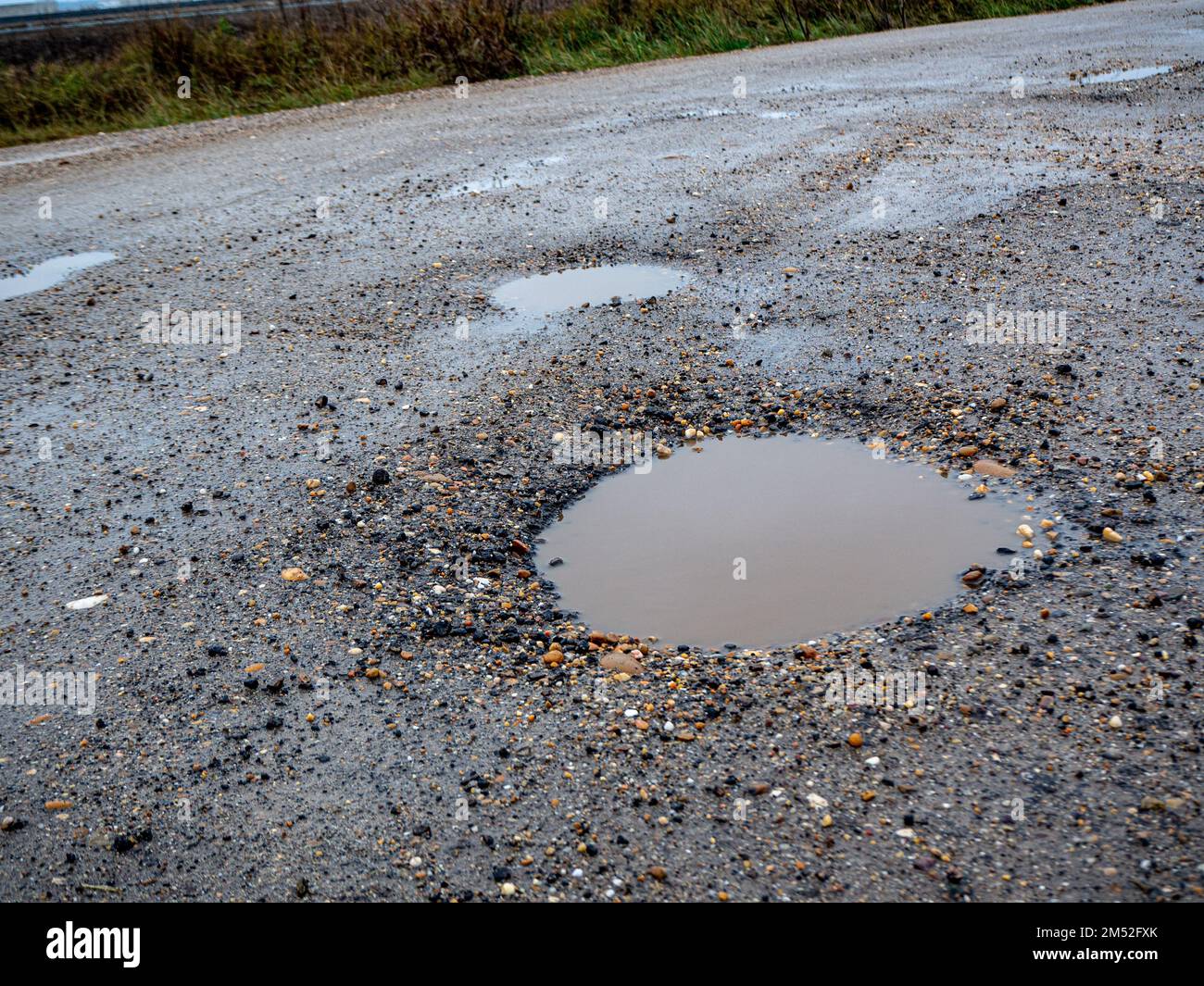 Close up of big pothole with dirty rain water of the road Stock Photo ...