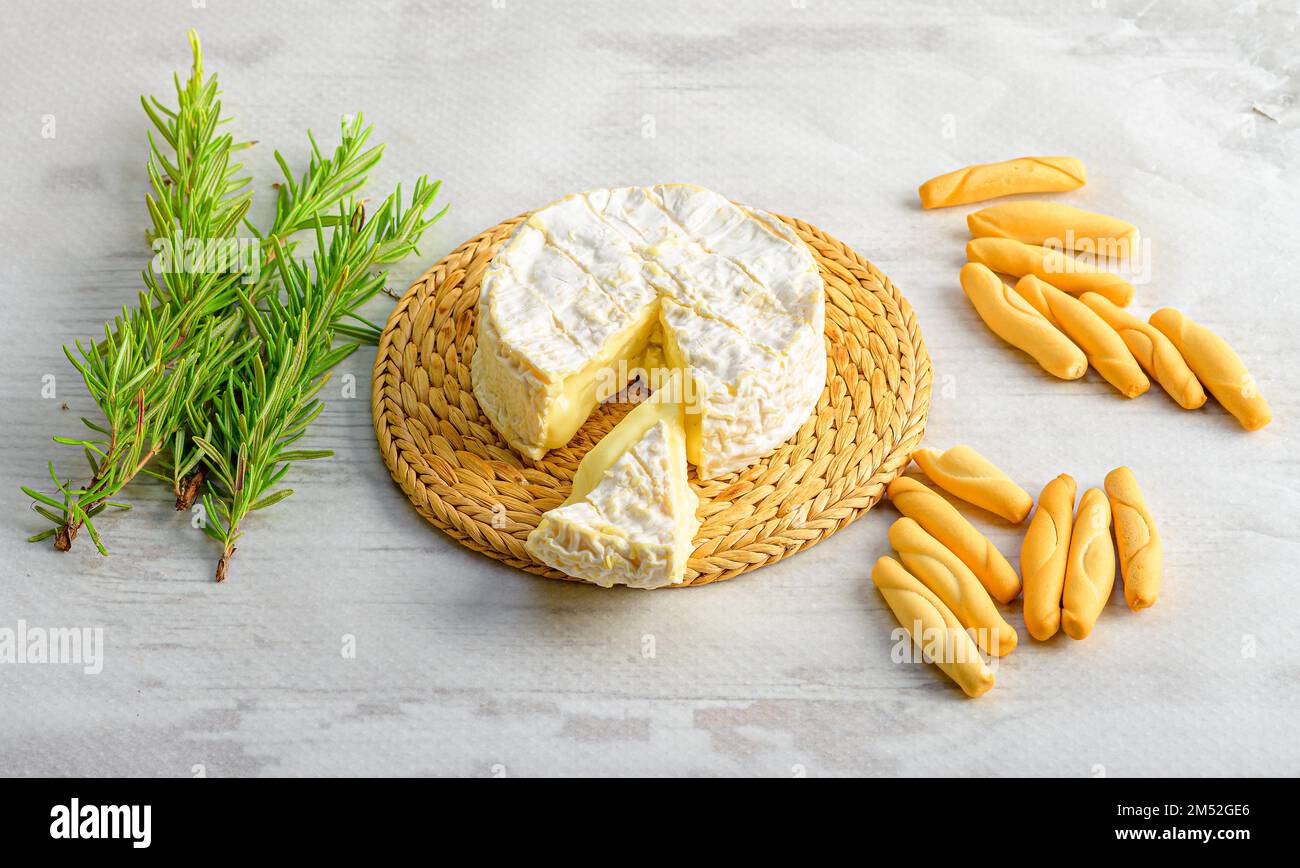 The camembert cheese on an esparto grass with mini breadsticks Stock ...