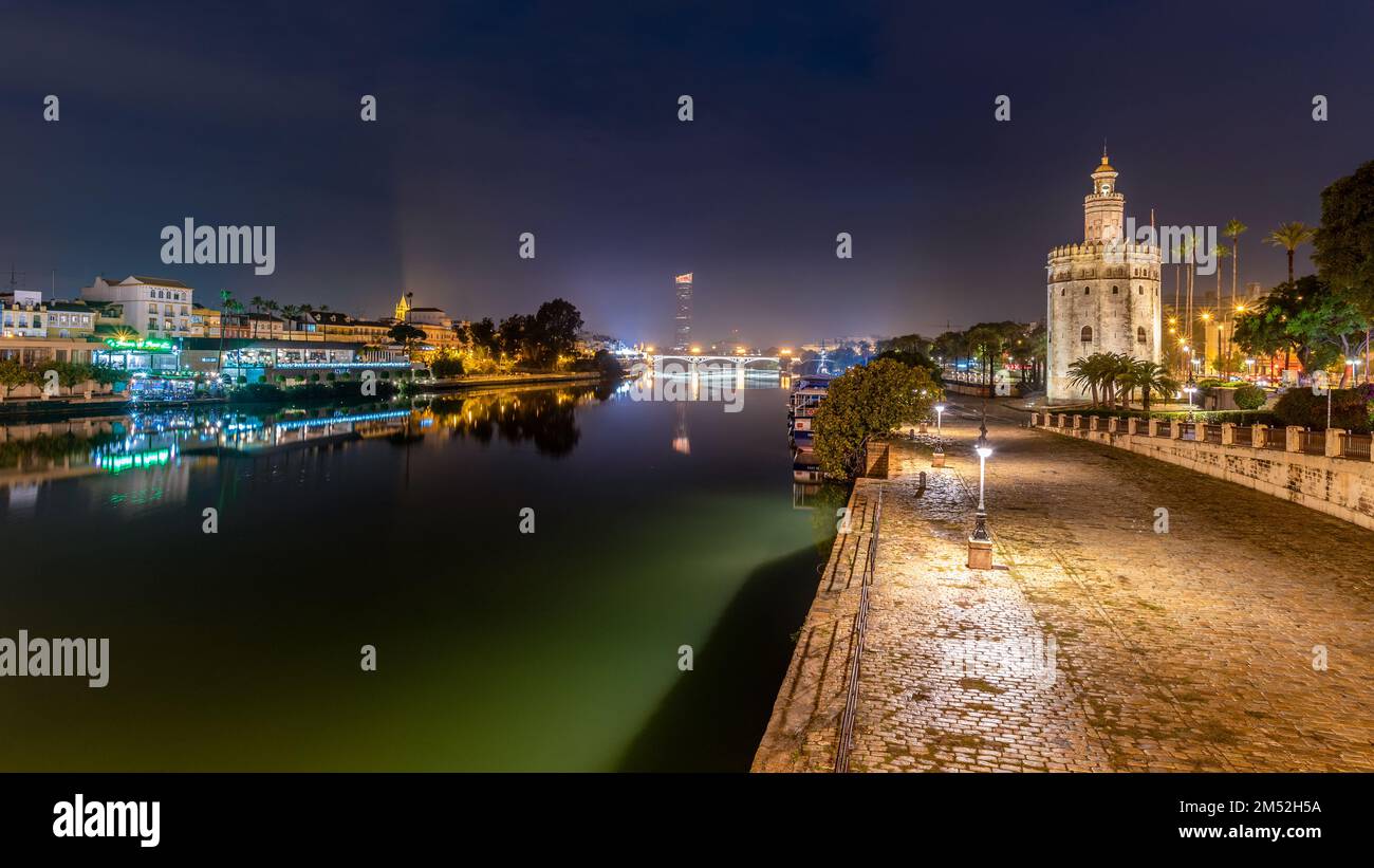Golden tower Torre del Oro watchtower along the Guadalquivir river at ...