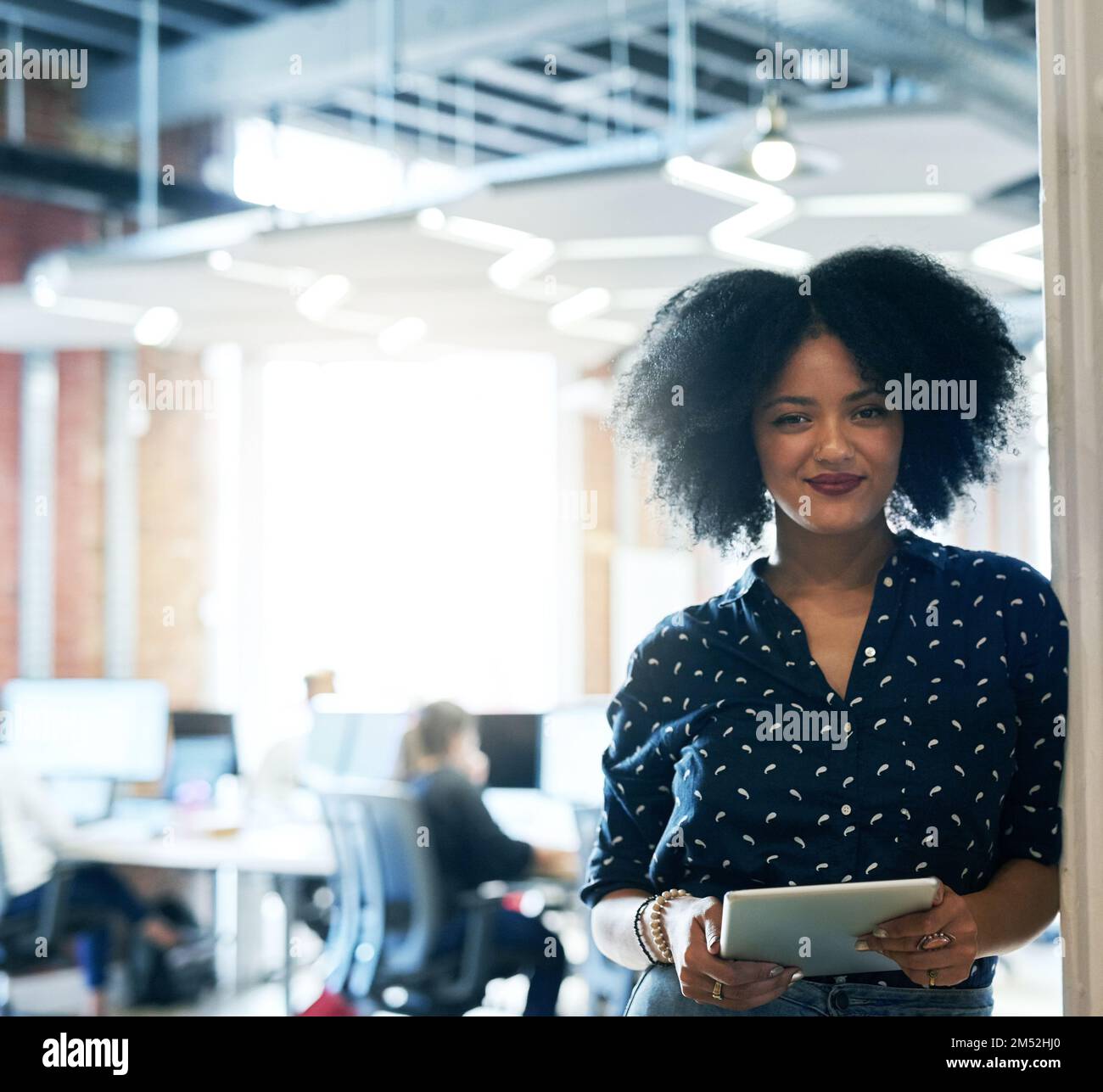 Work hard is her motto. a young female designer working in her office ...