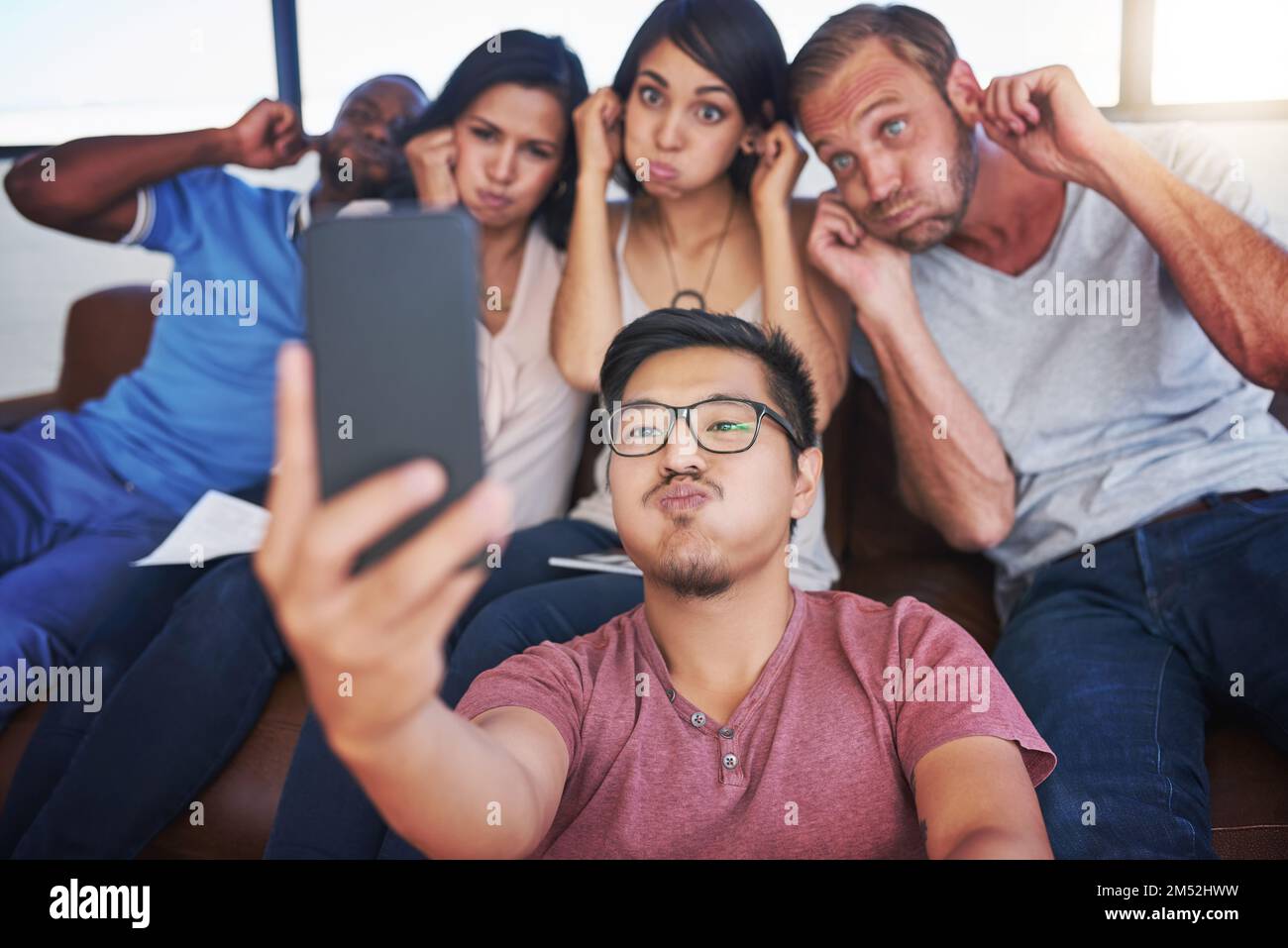 Showing off their silly side. a happy group of creative colleagues ...