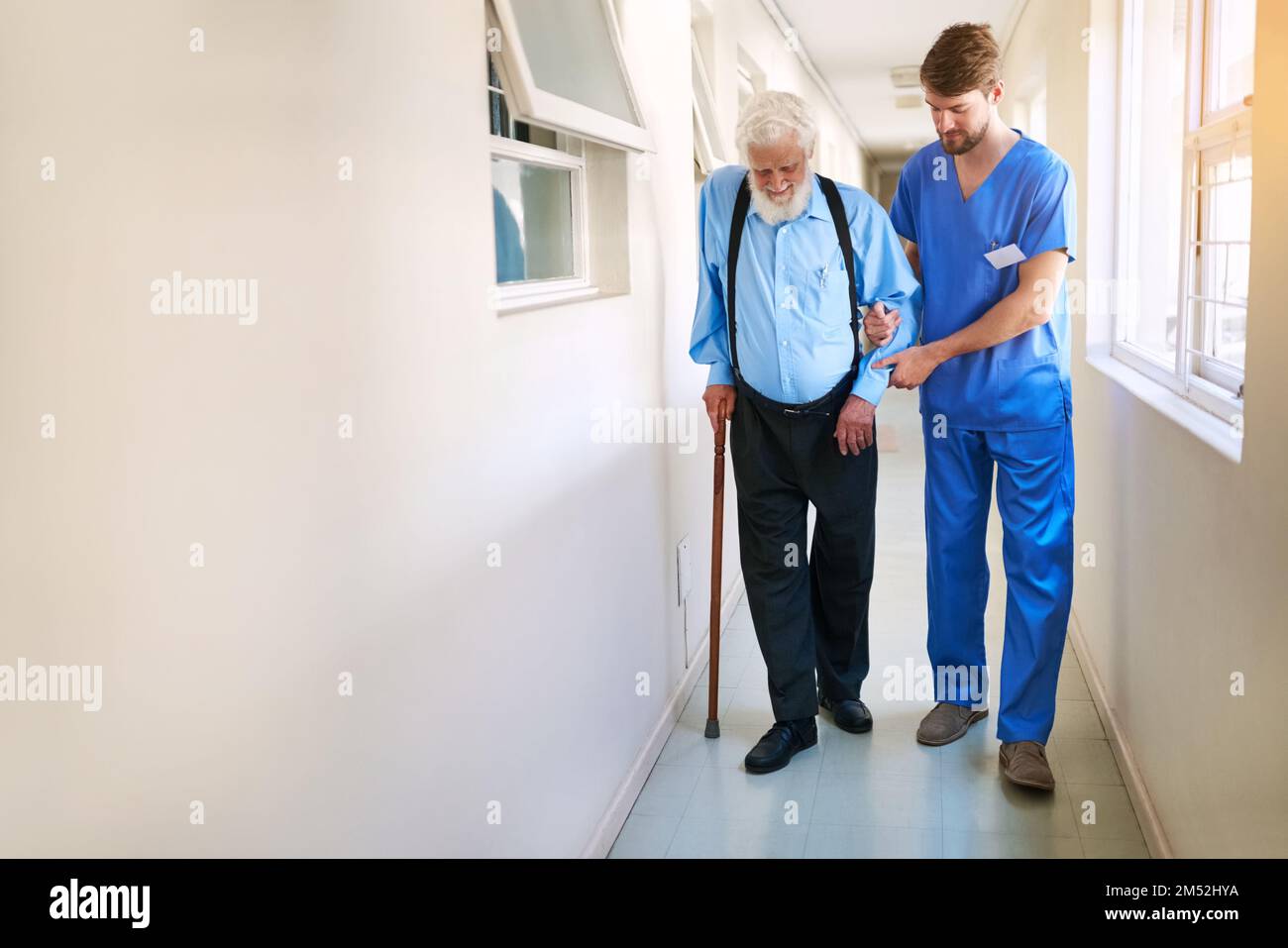 Walking the road to recovery together. a young doctor helping his ...
