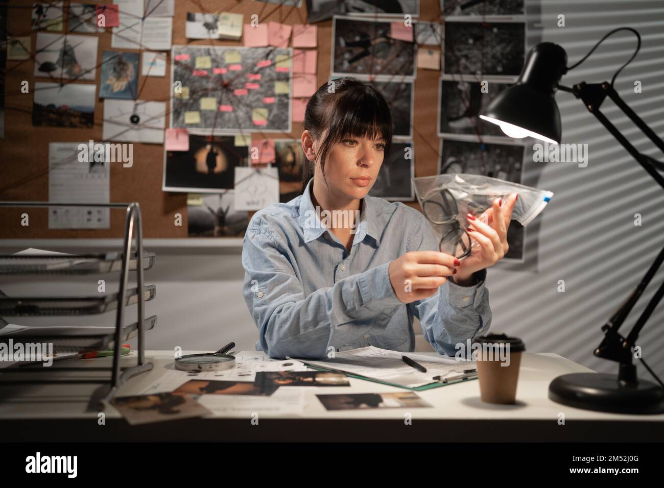 Detective working in her office with evidence. Copy space Stock Photo ...