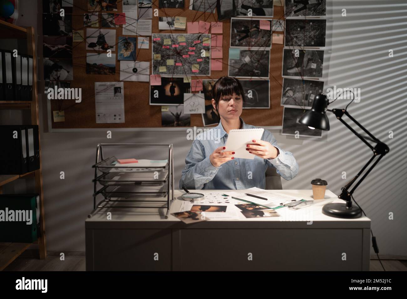 Detective working at desk in her office. Copy space Stock Photo - Alamy