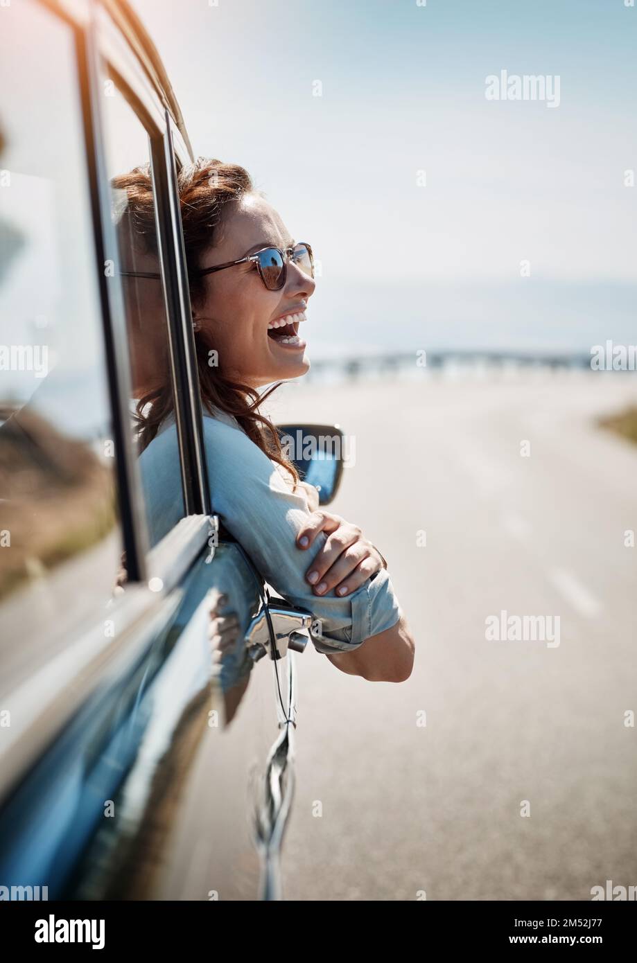Road trips put me in a happy mood. an attractive woman hanging out of a ...