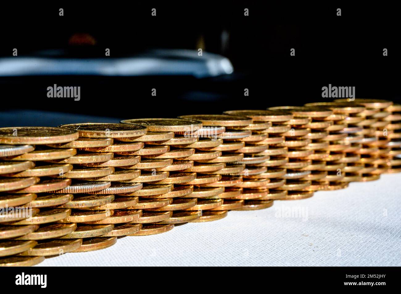 Stack of gold and silver dollar coins forming a border wall Stock Photo ...