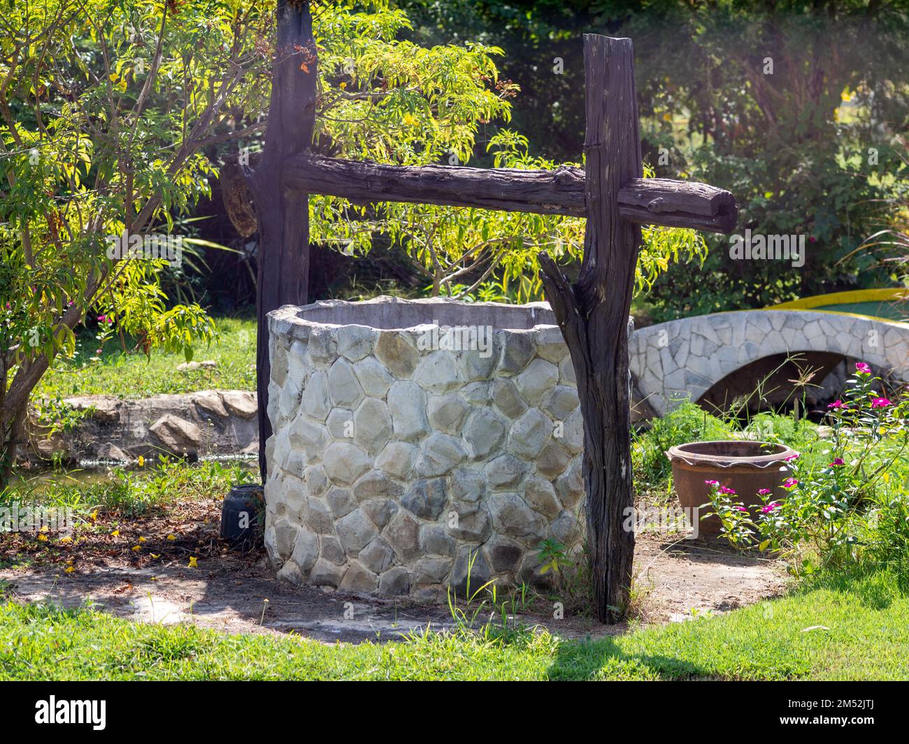 old well made of bricks and wooden pole Stock Photo - Alamy